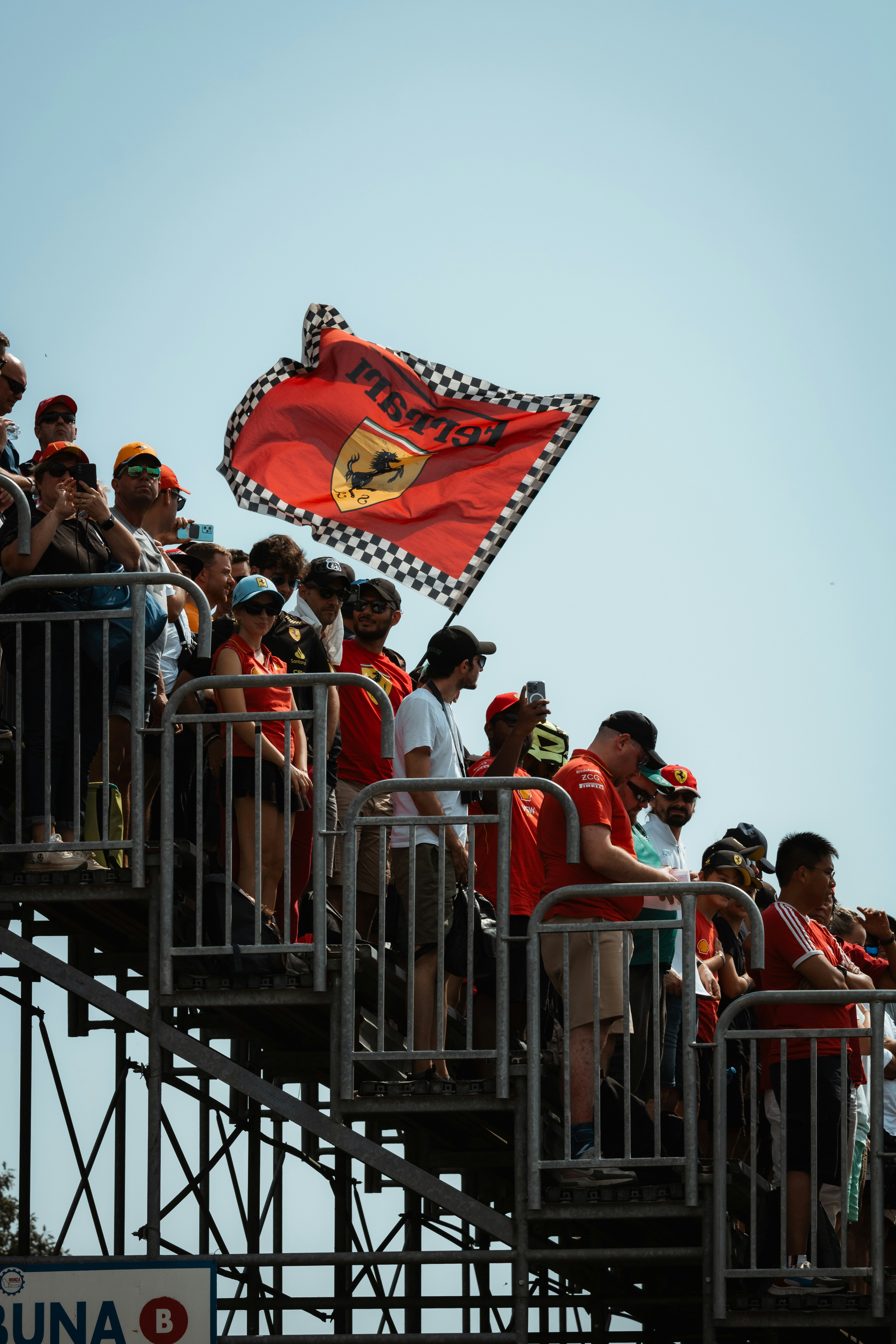 Flag Wave over the Stairs: Ferrari Fans Rally Above the Rail