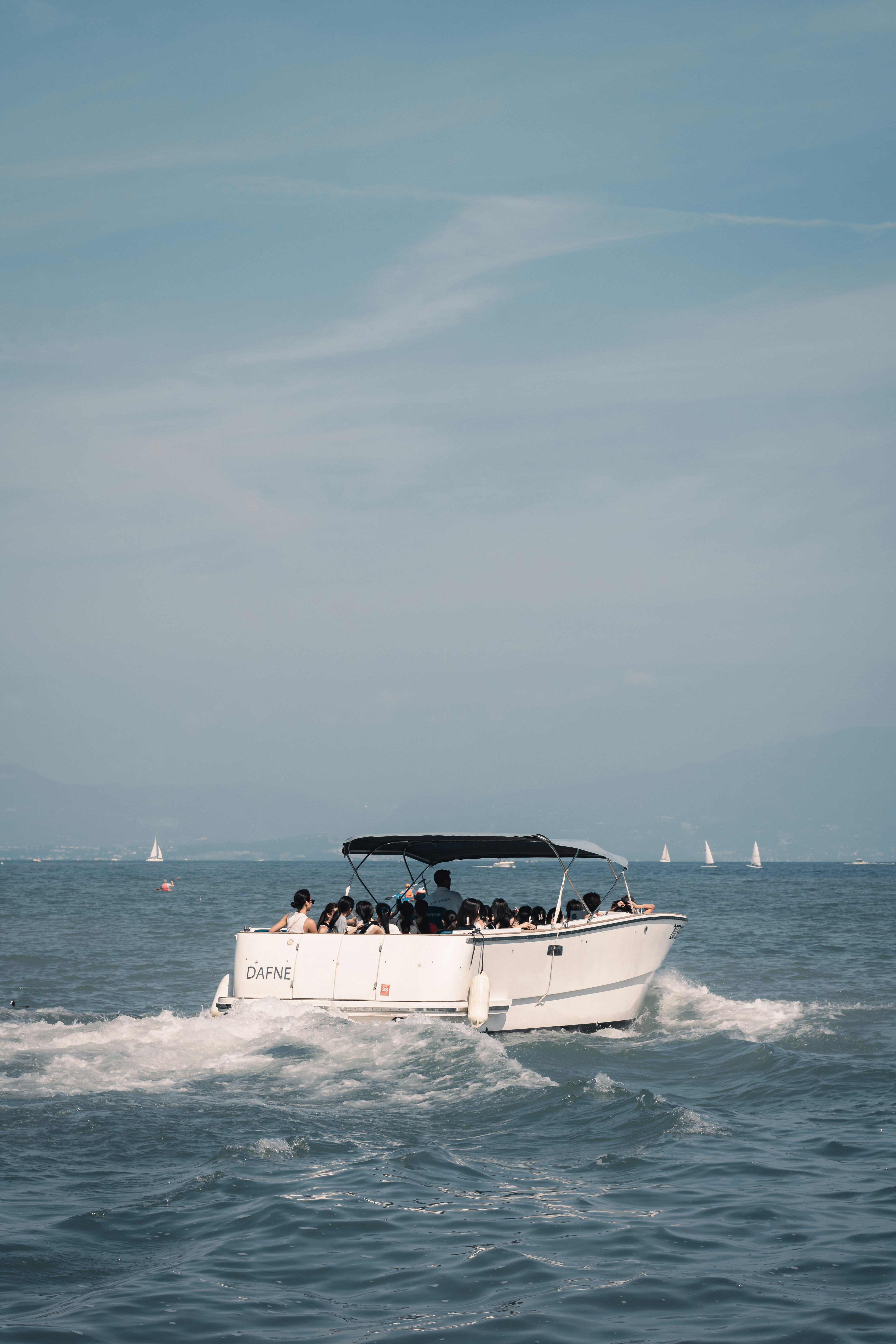 Boat in a Quiet Sea: a busied hull cutting through blue horizon