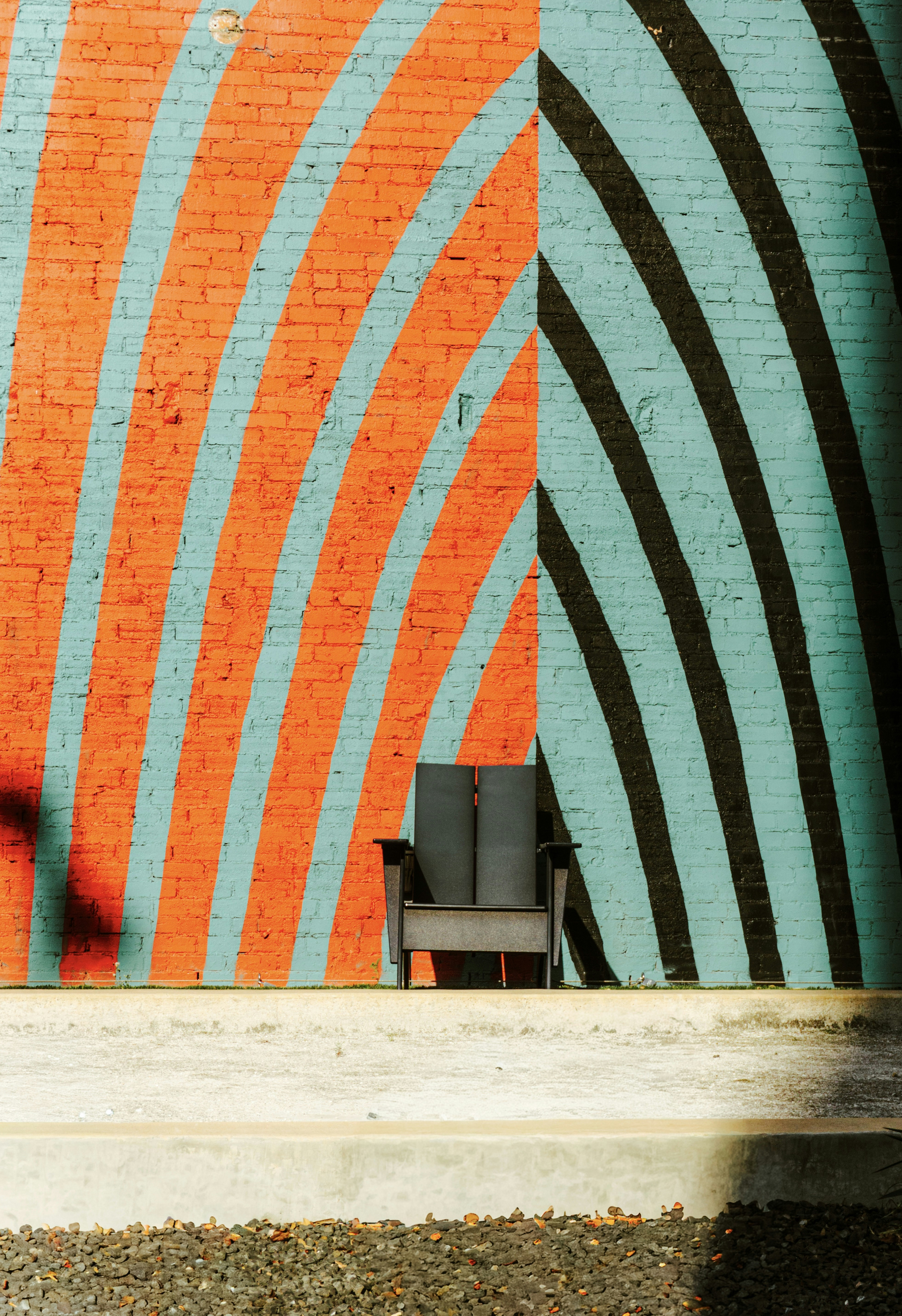 Chiaroscuro Arc: A Bench Beneath Striped Enamel