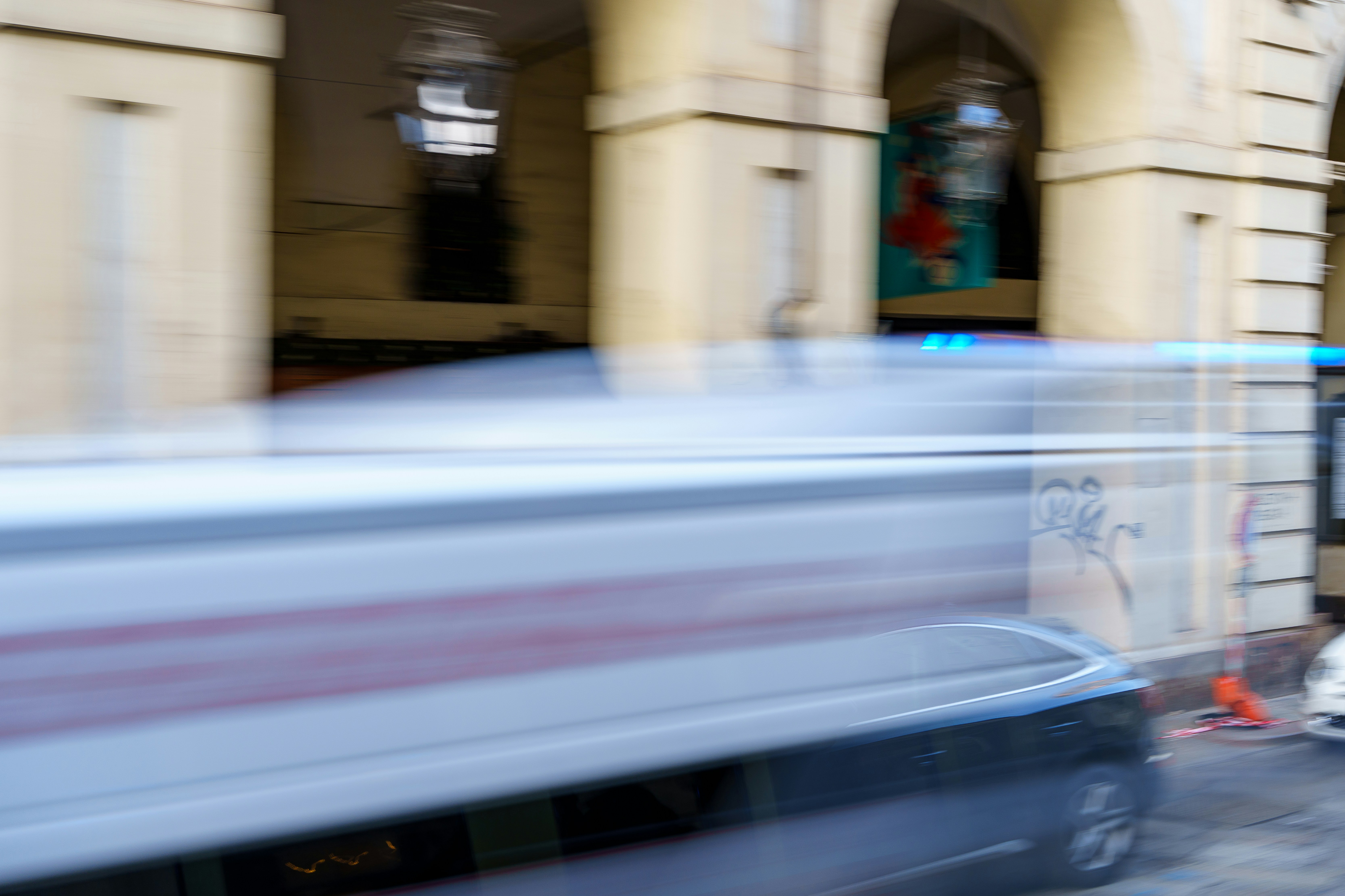 Urban Passage: A Blurred Train Whisk Across a Historic Facade