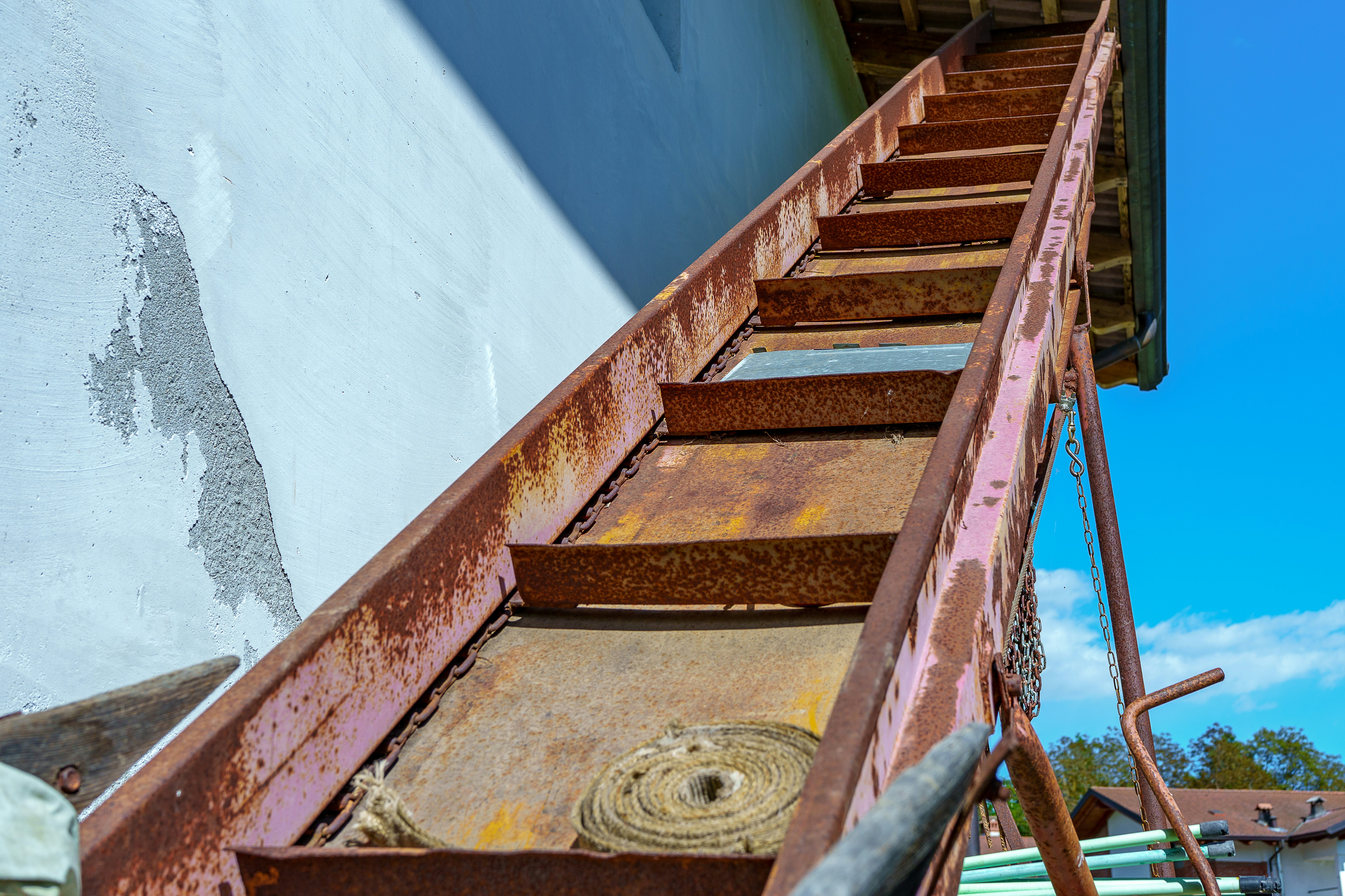 Rusted Staircase Rising under a Bright Blue Sky
