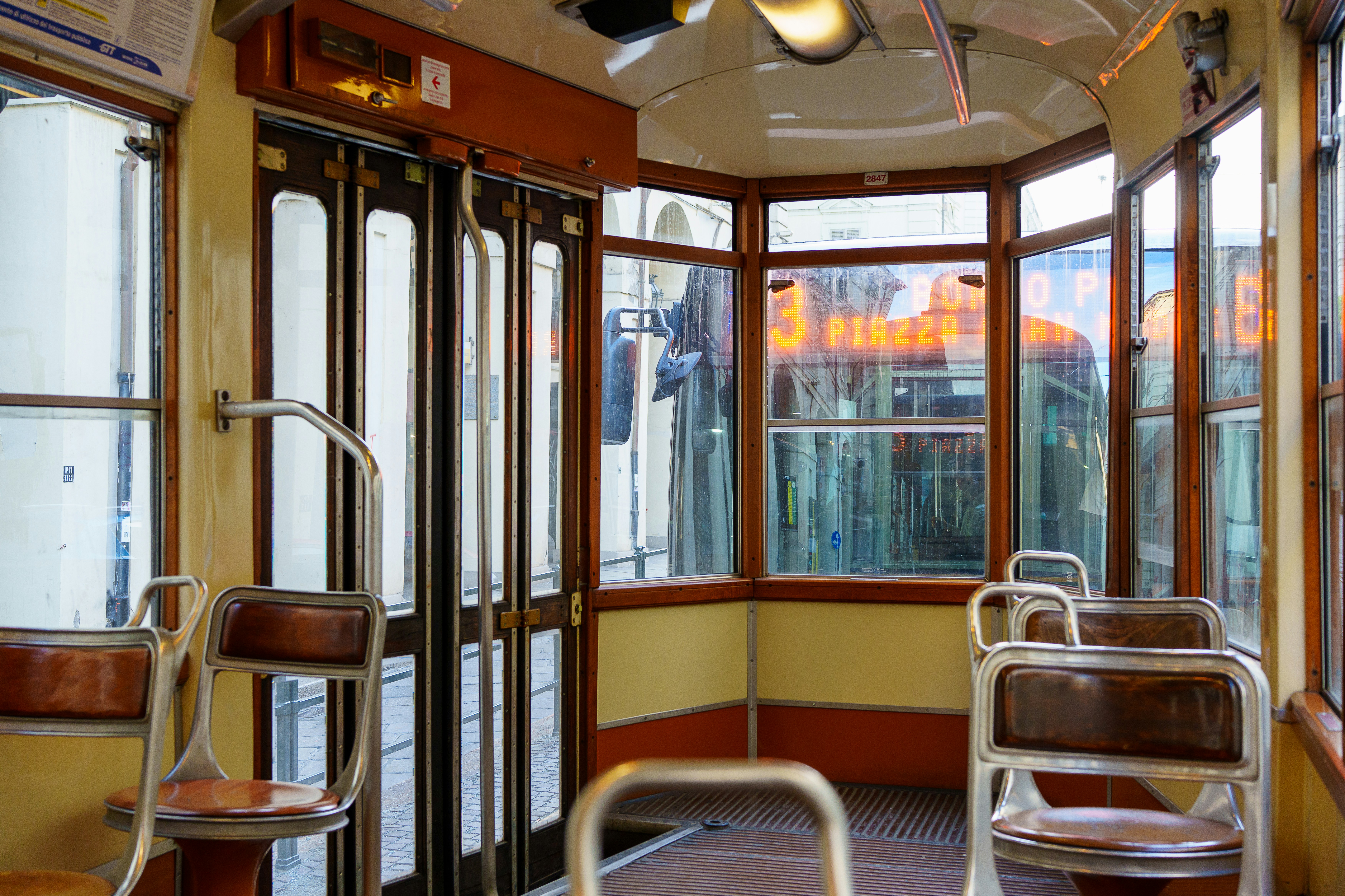 Quiet tram at the station: amber wood and chrome cabins
