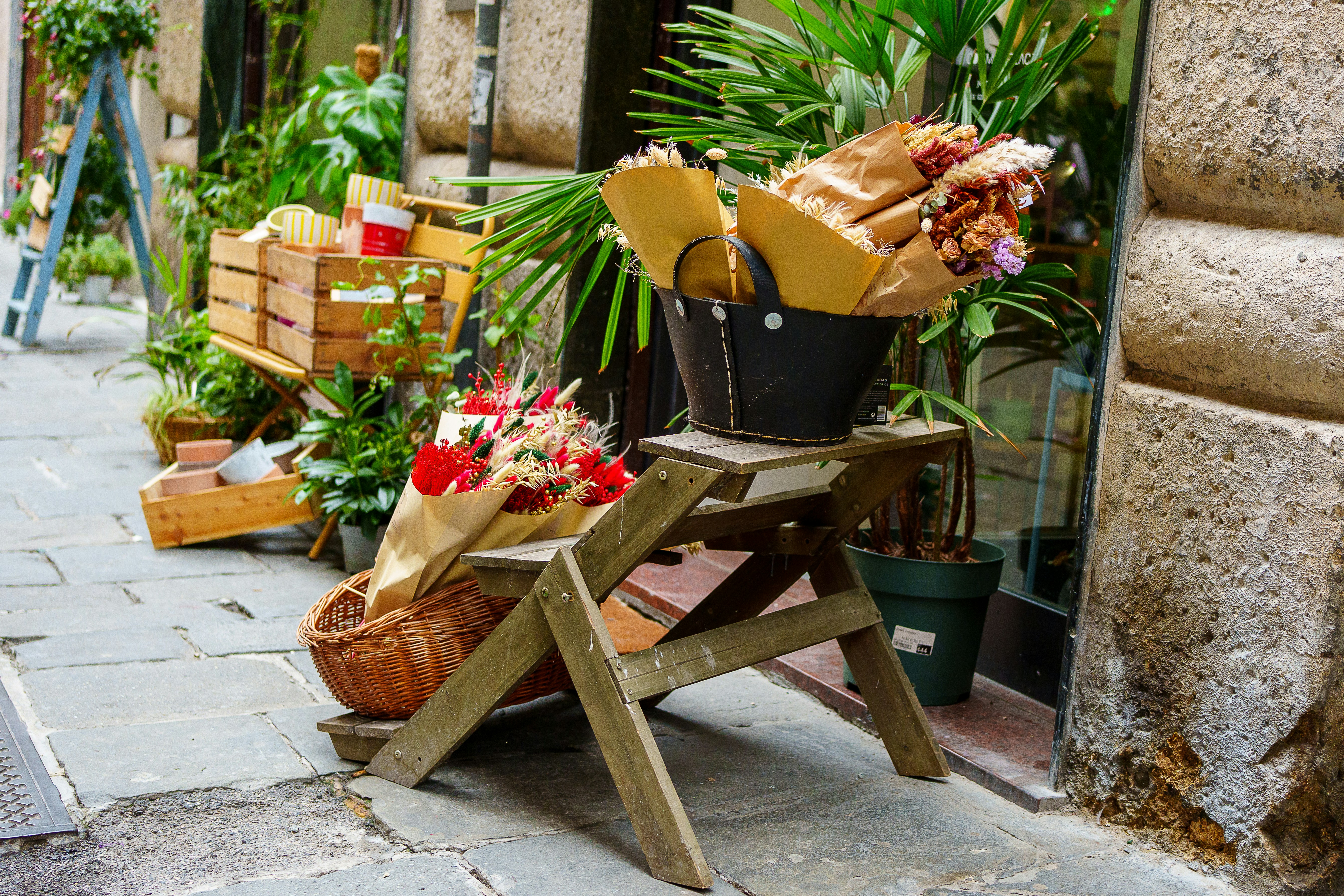 Bouquets in a rustic street stand, awaiting a cheerful handoff