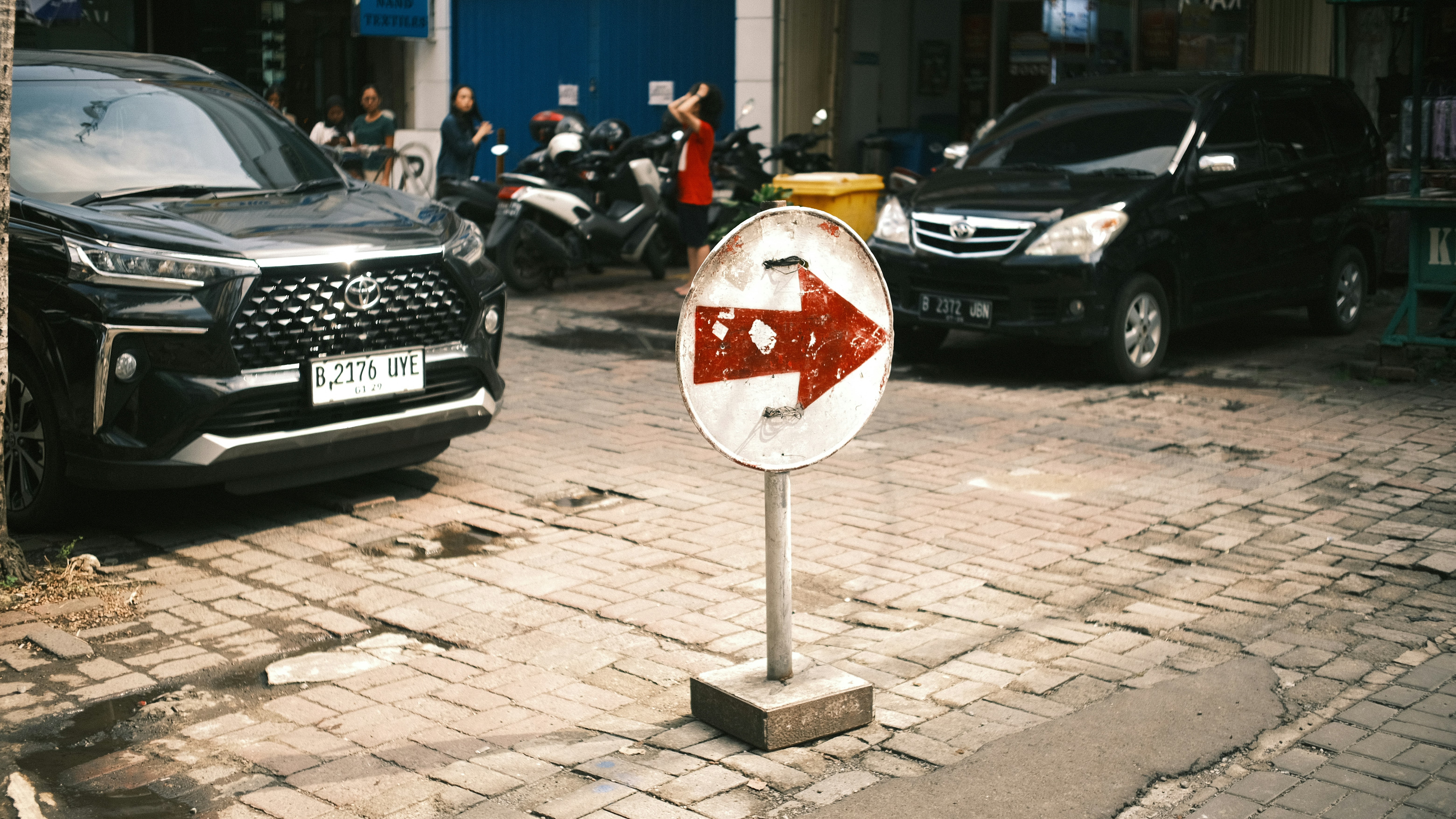 Red Arrow in a Street Spotlight: Centered Sign, Busy Backdrop