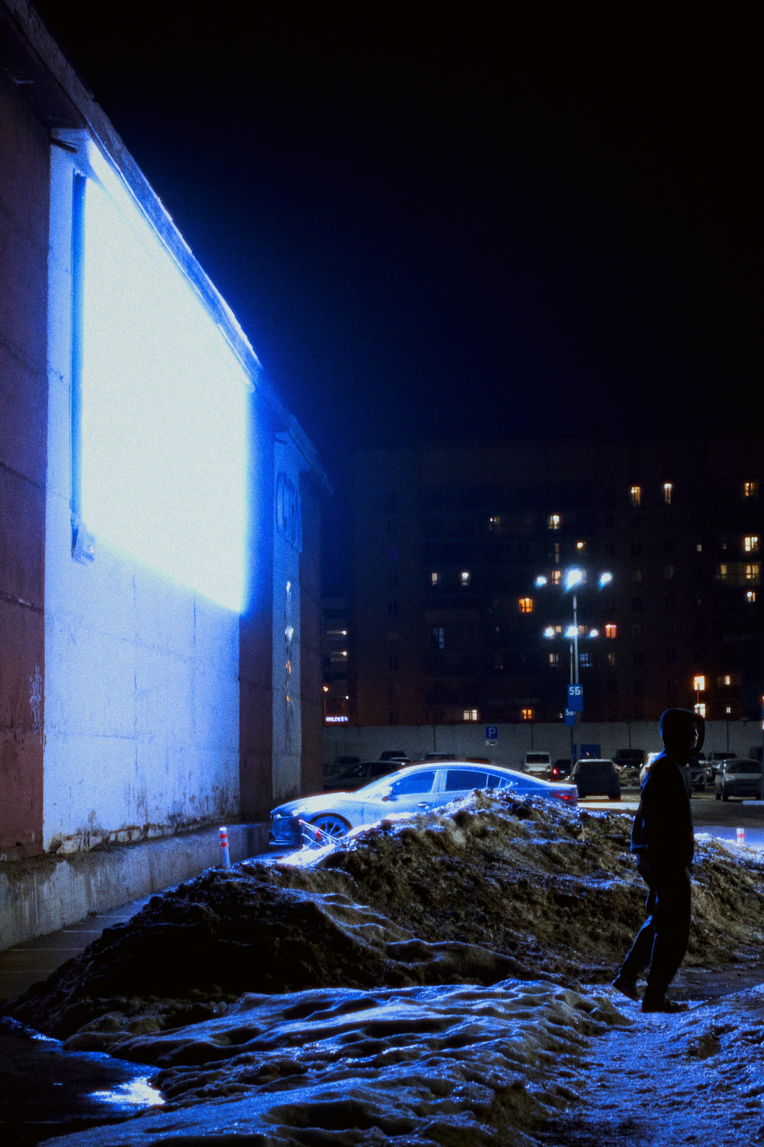 Blue Neon Edge: A Night Exterior with a Lone Silhouette