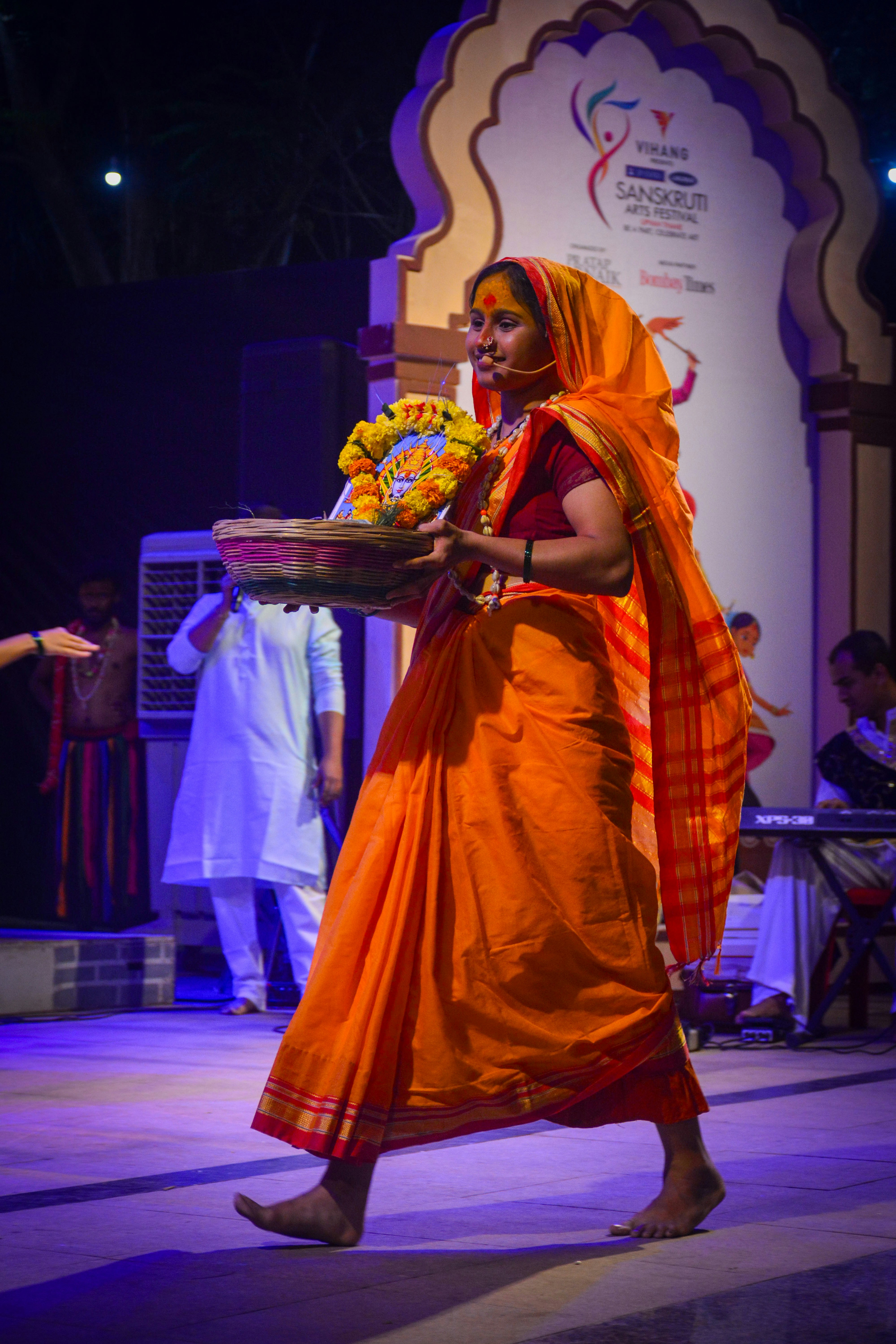 Basket of blossoms and grace: a dancer steps through a festive doorway