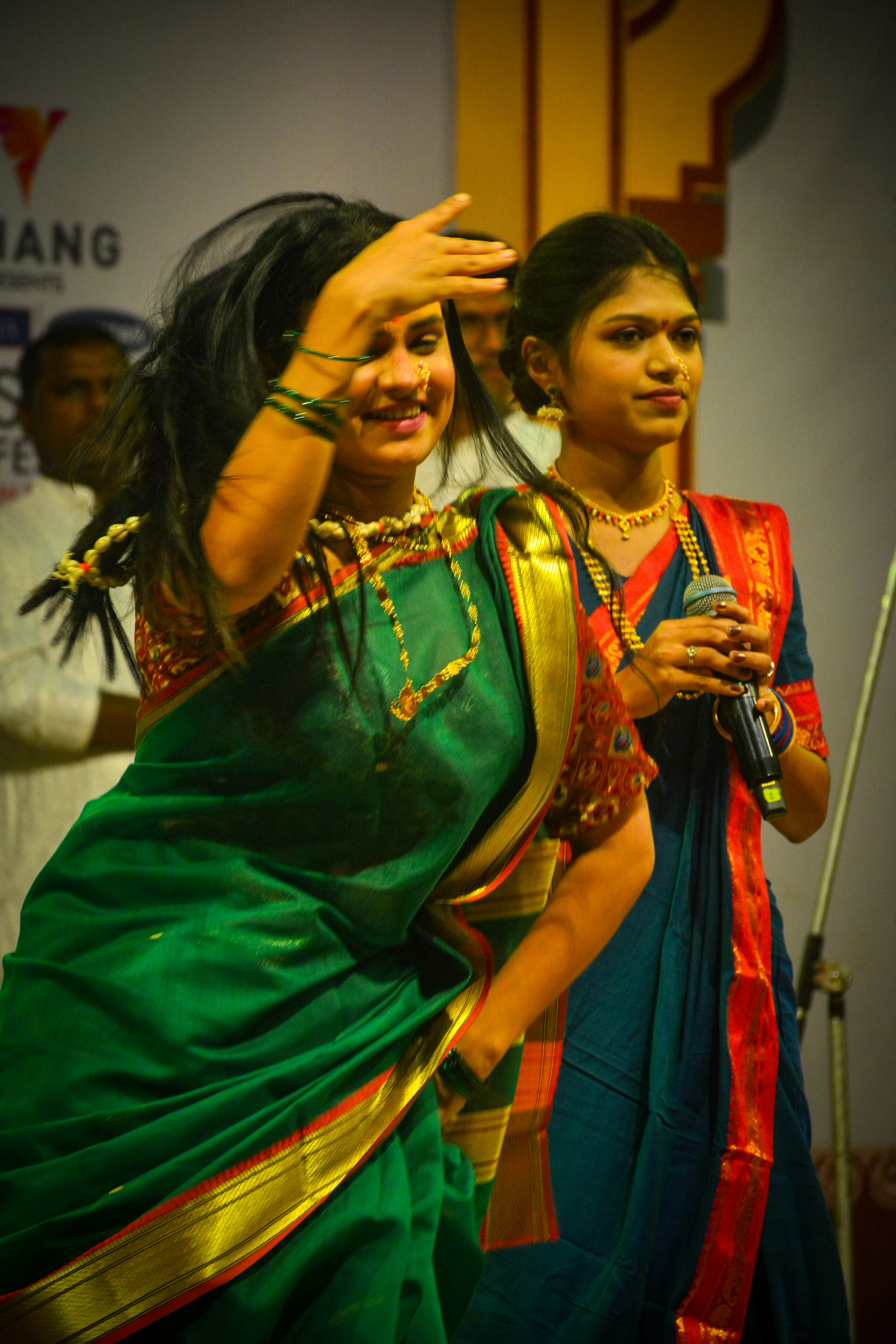 Green sari, bright energy: a lively stage moment with two dancers