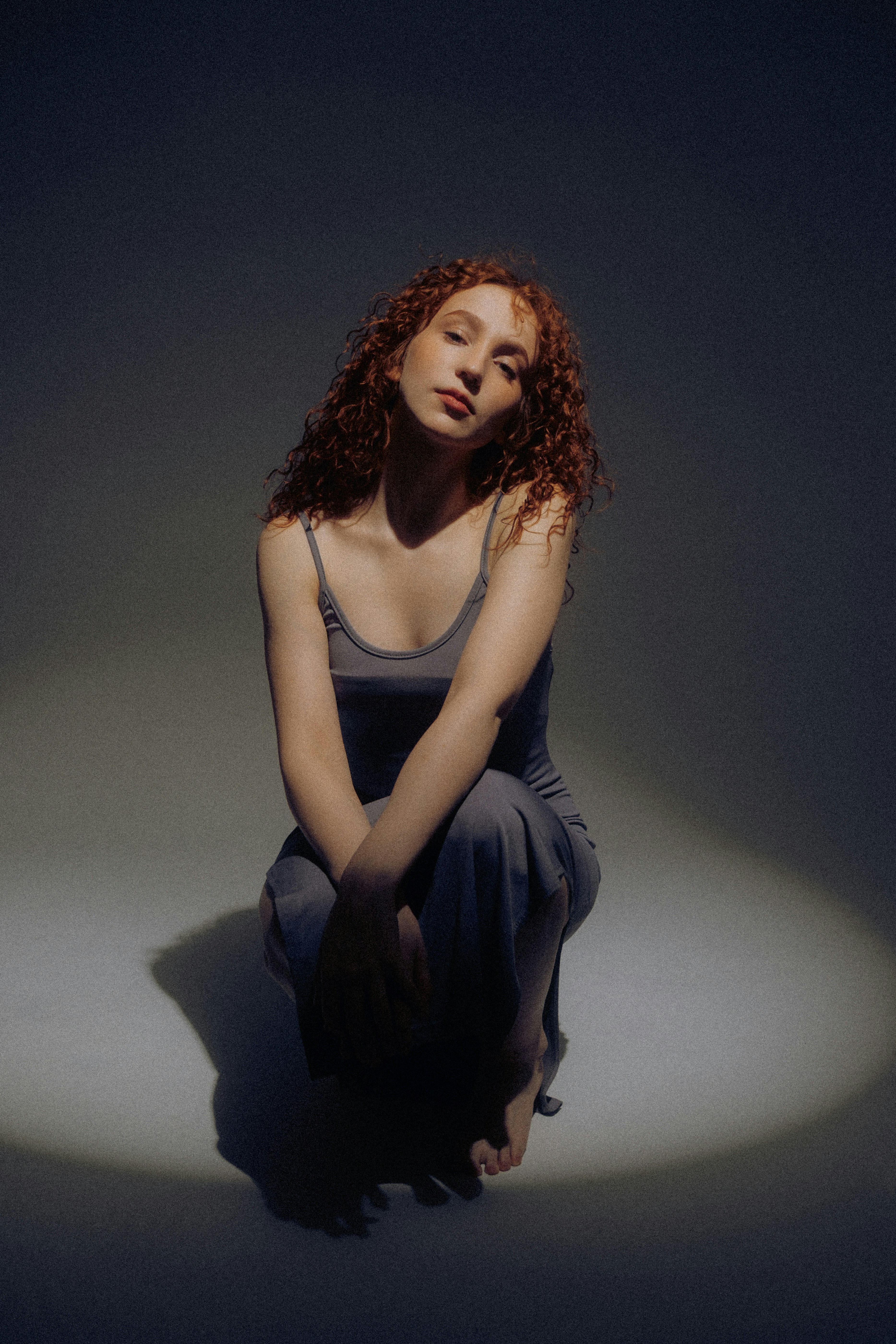 Moonlit Poise: Curling Red Hair in a Spotlight