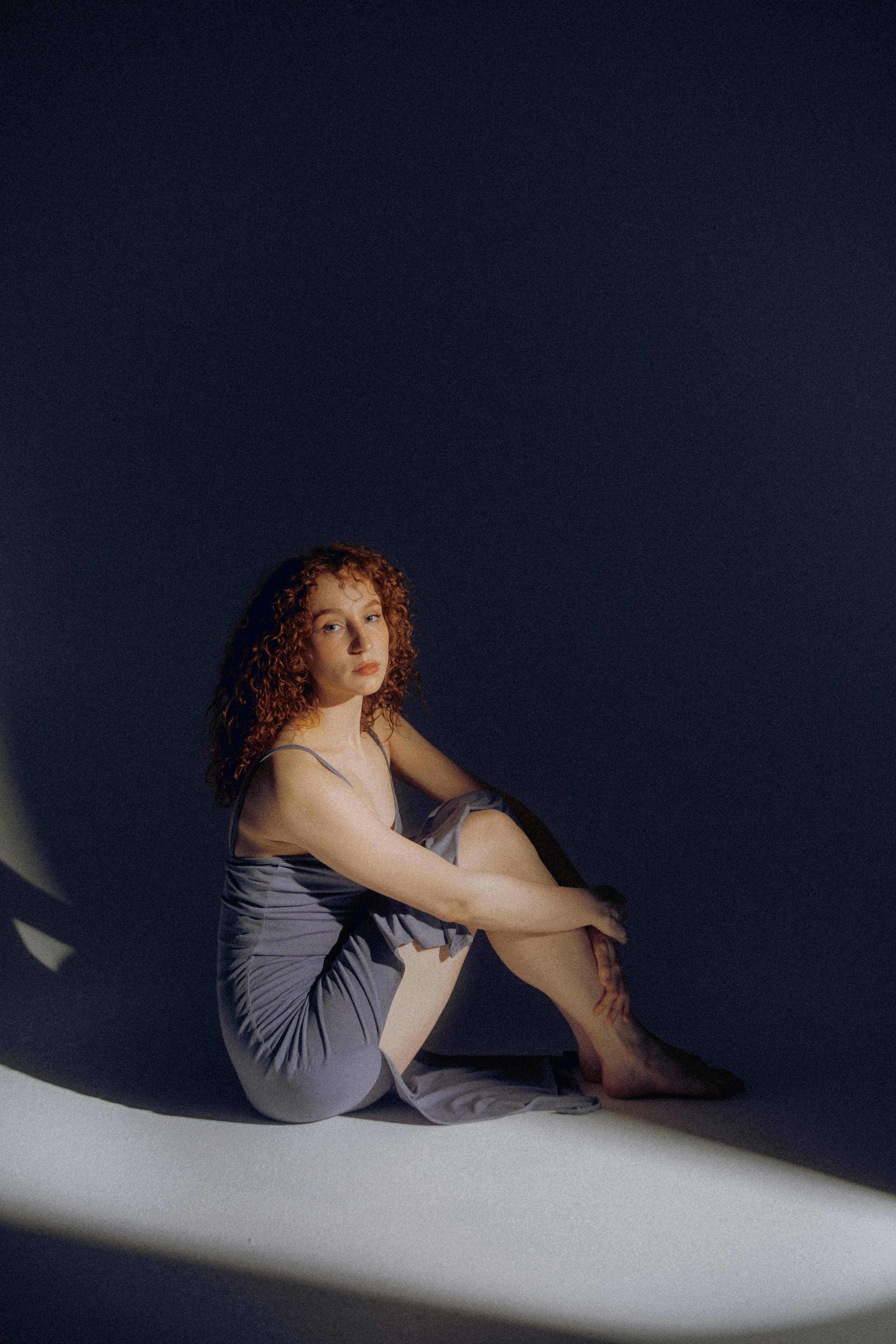 Solitary Redhead in a Moonlit Studio