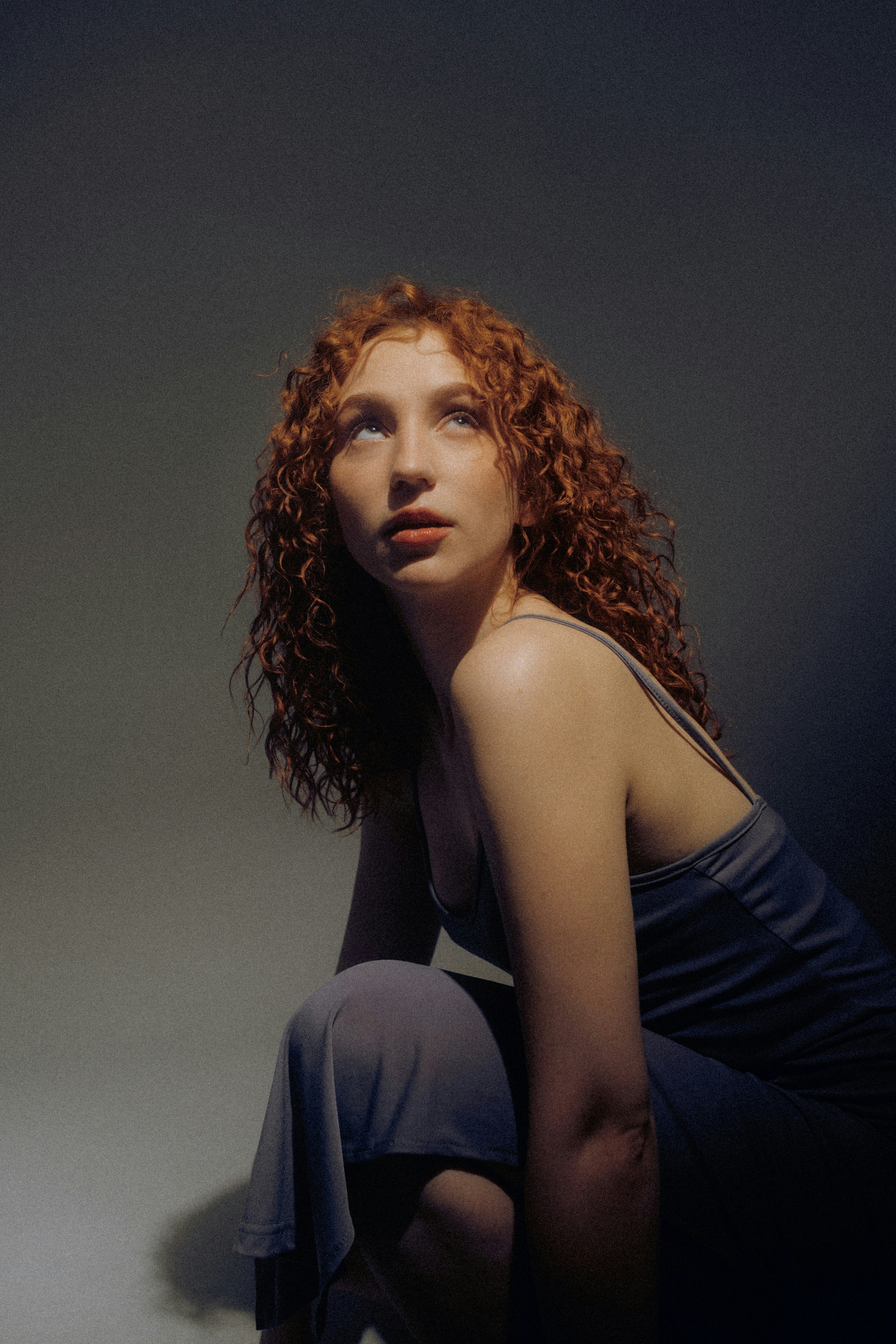 Curled Auburn Gaze in a Quiet Studio