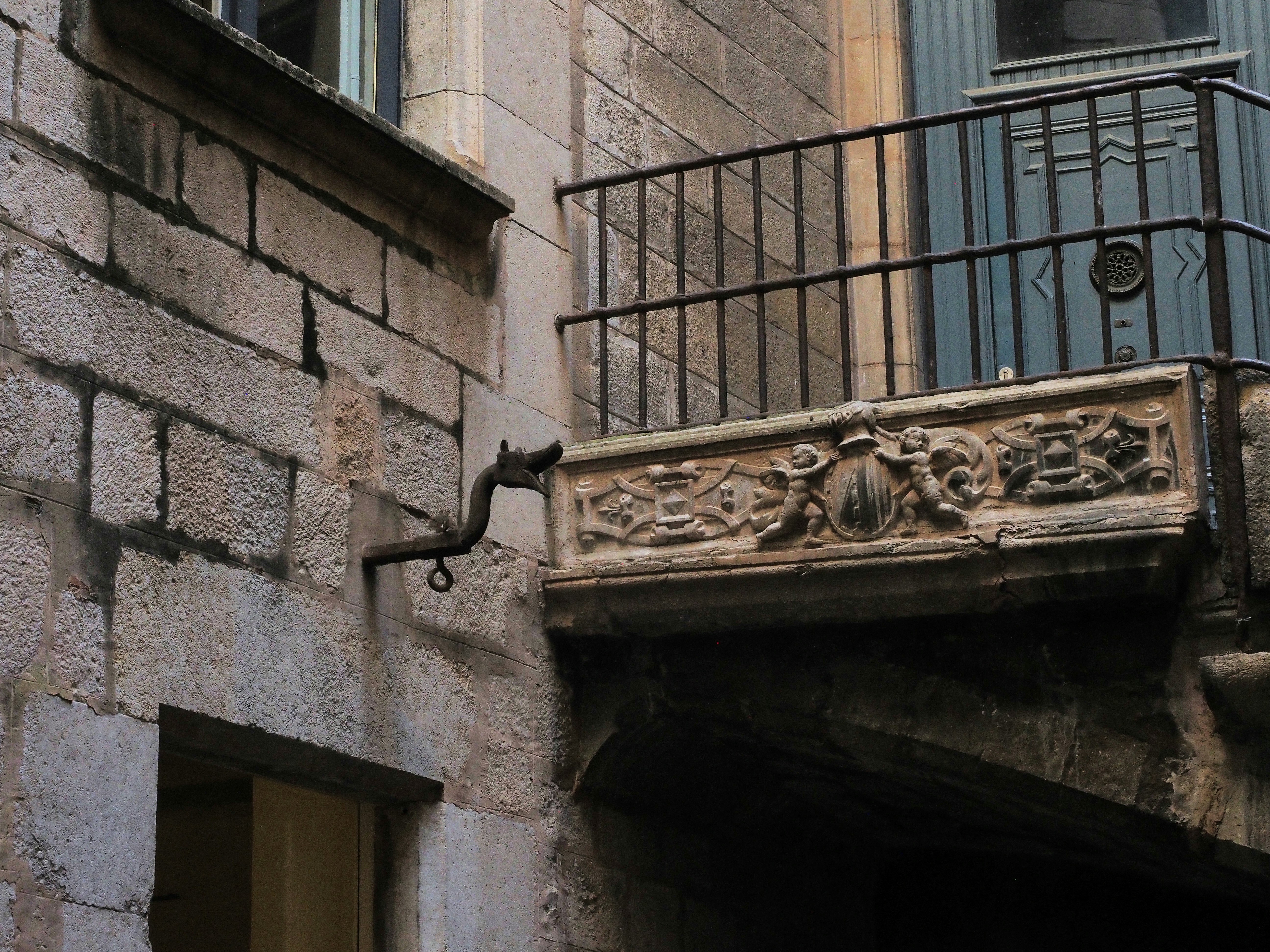 Stone Balcony Overhang and Weathered Facade