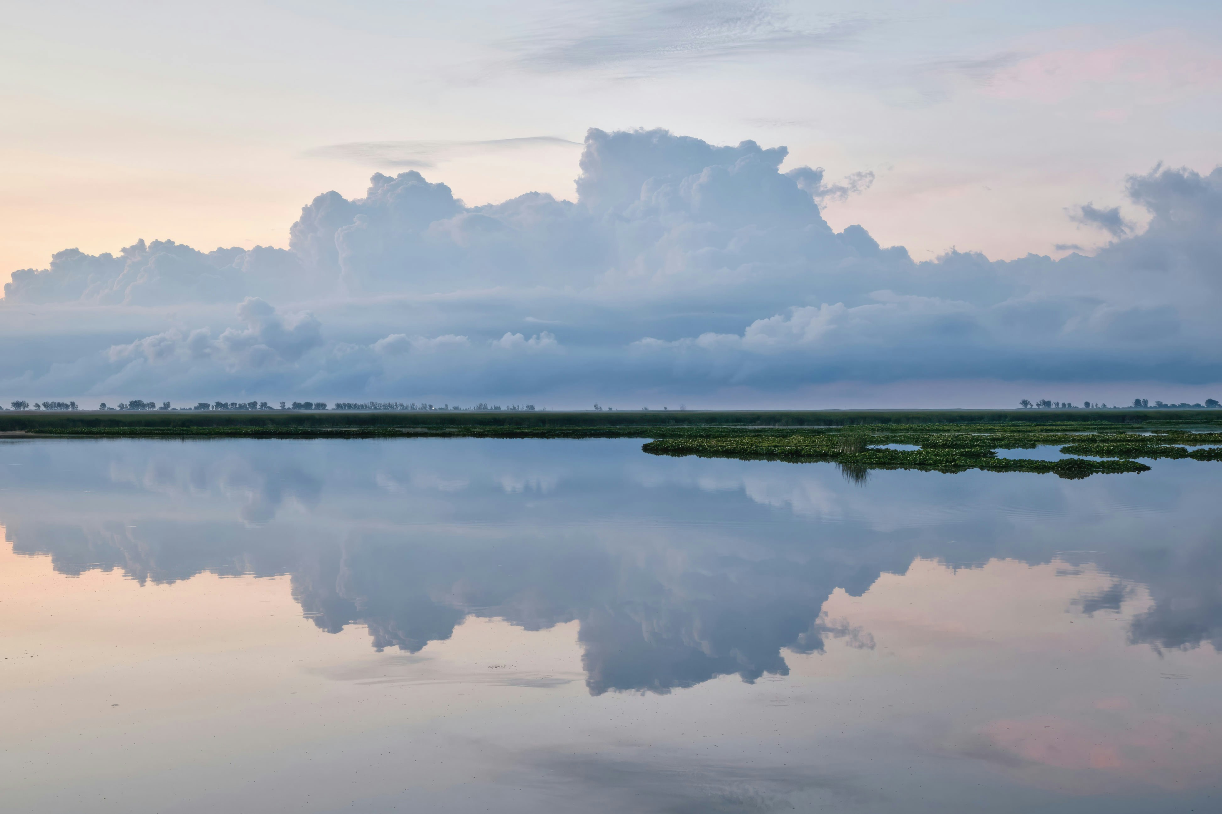 Mirror Lake at Dusk: Clouds Reach Across a Calm Horizon