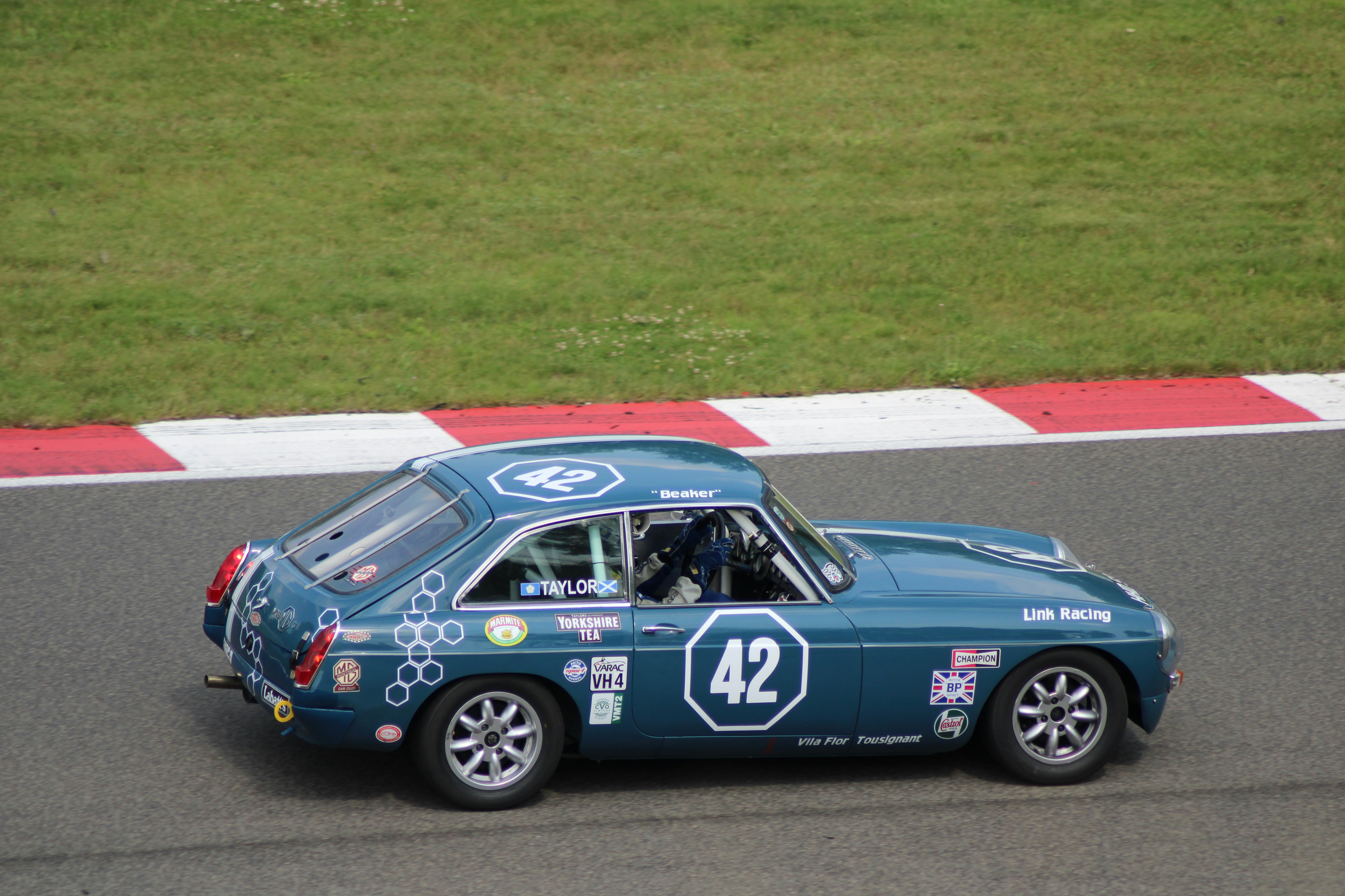 Blue vintage racer in motion on a race track