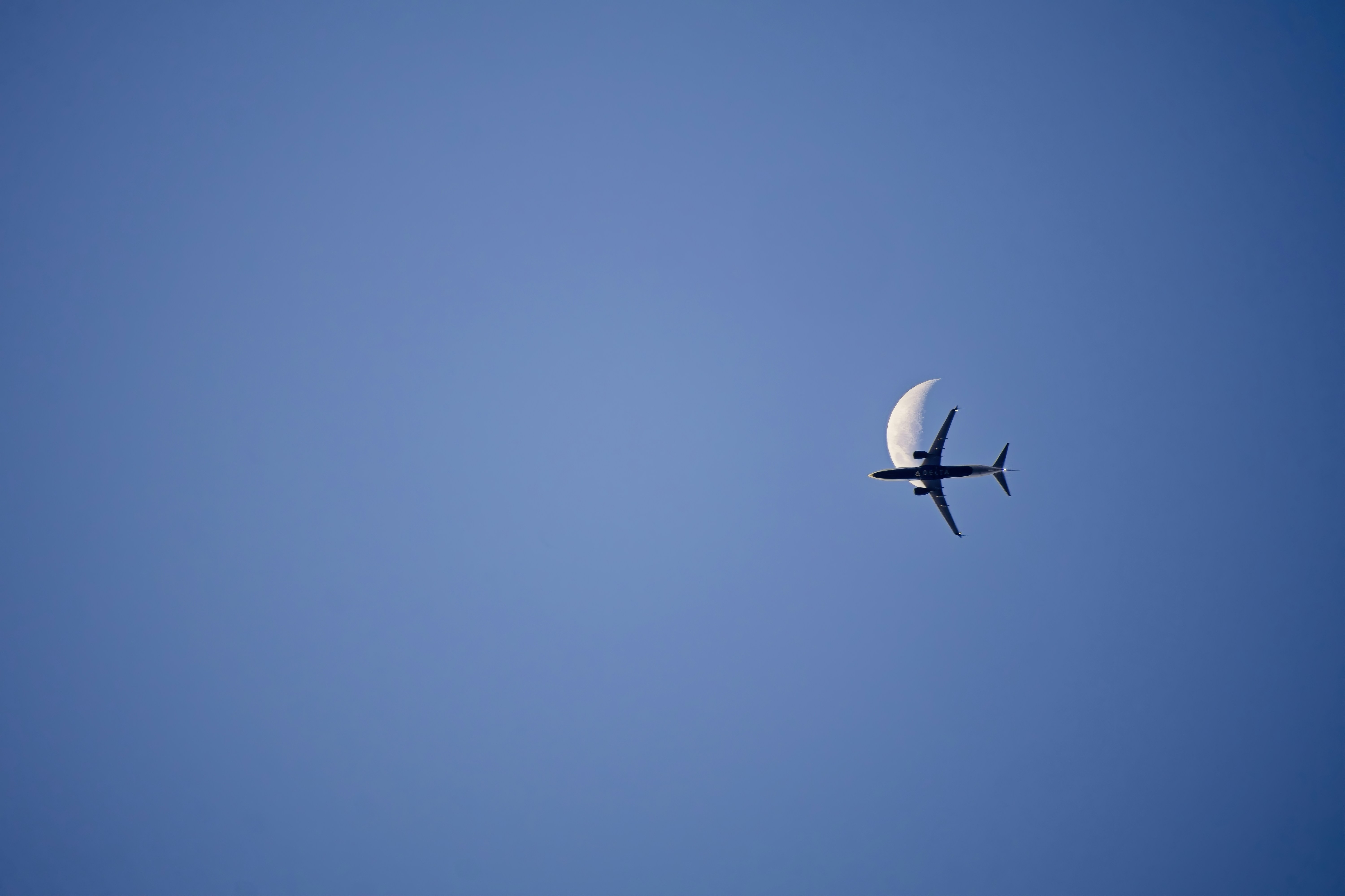 Lone crescent and jet: a quiet high-altitude pass