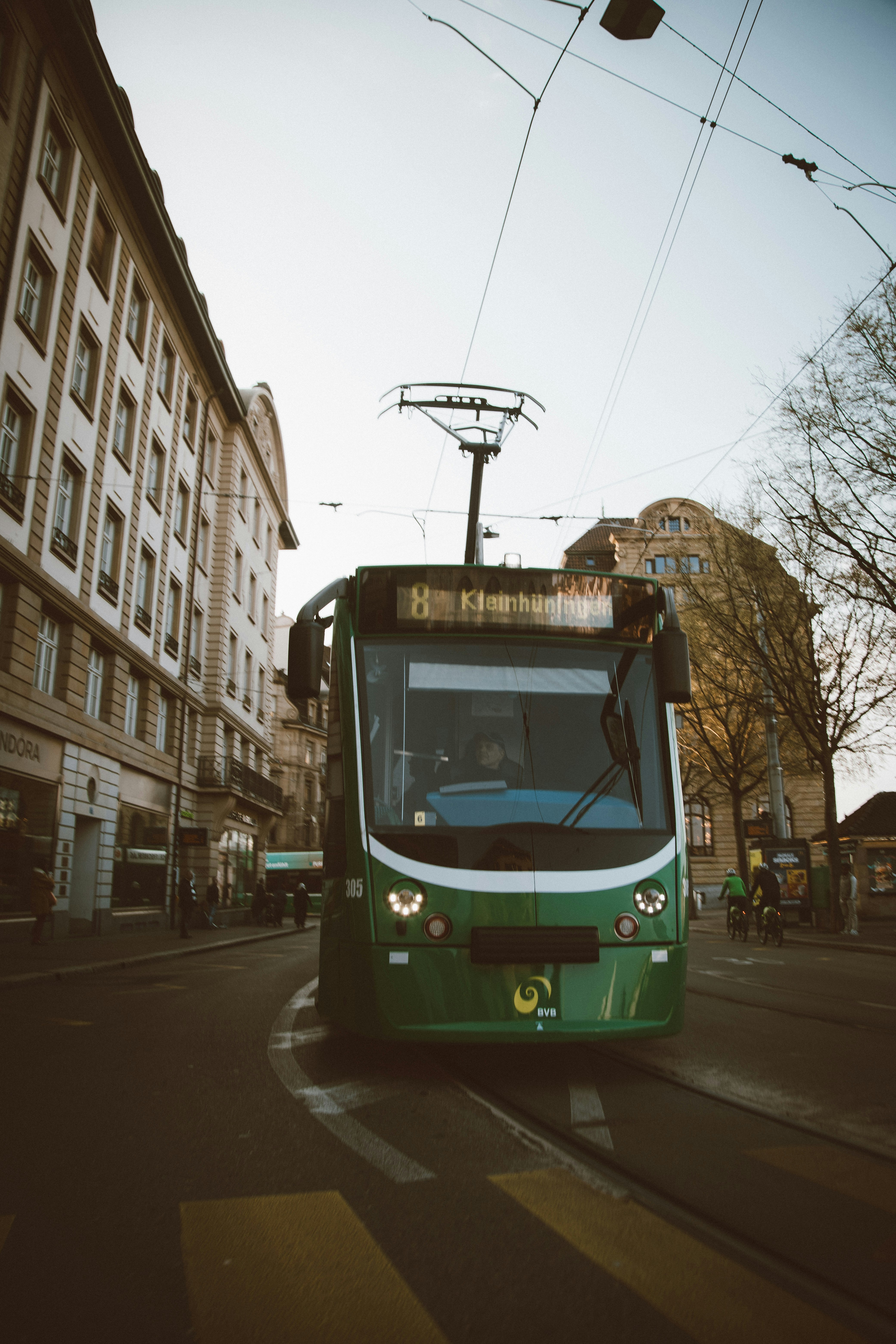 Green Tram Stares Down the Street: A City Moment in Focus