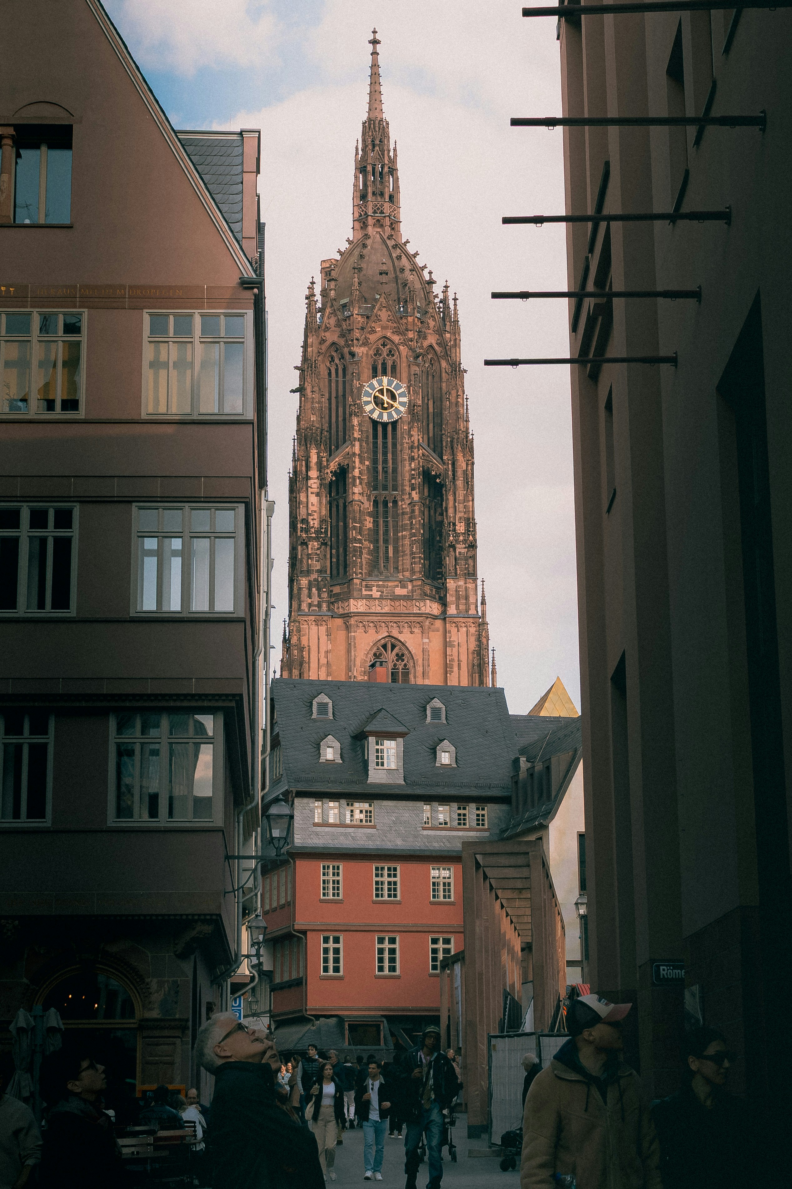 Gothic Spire Ascending Between Narrow Facades
