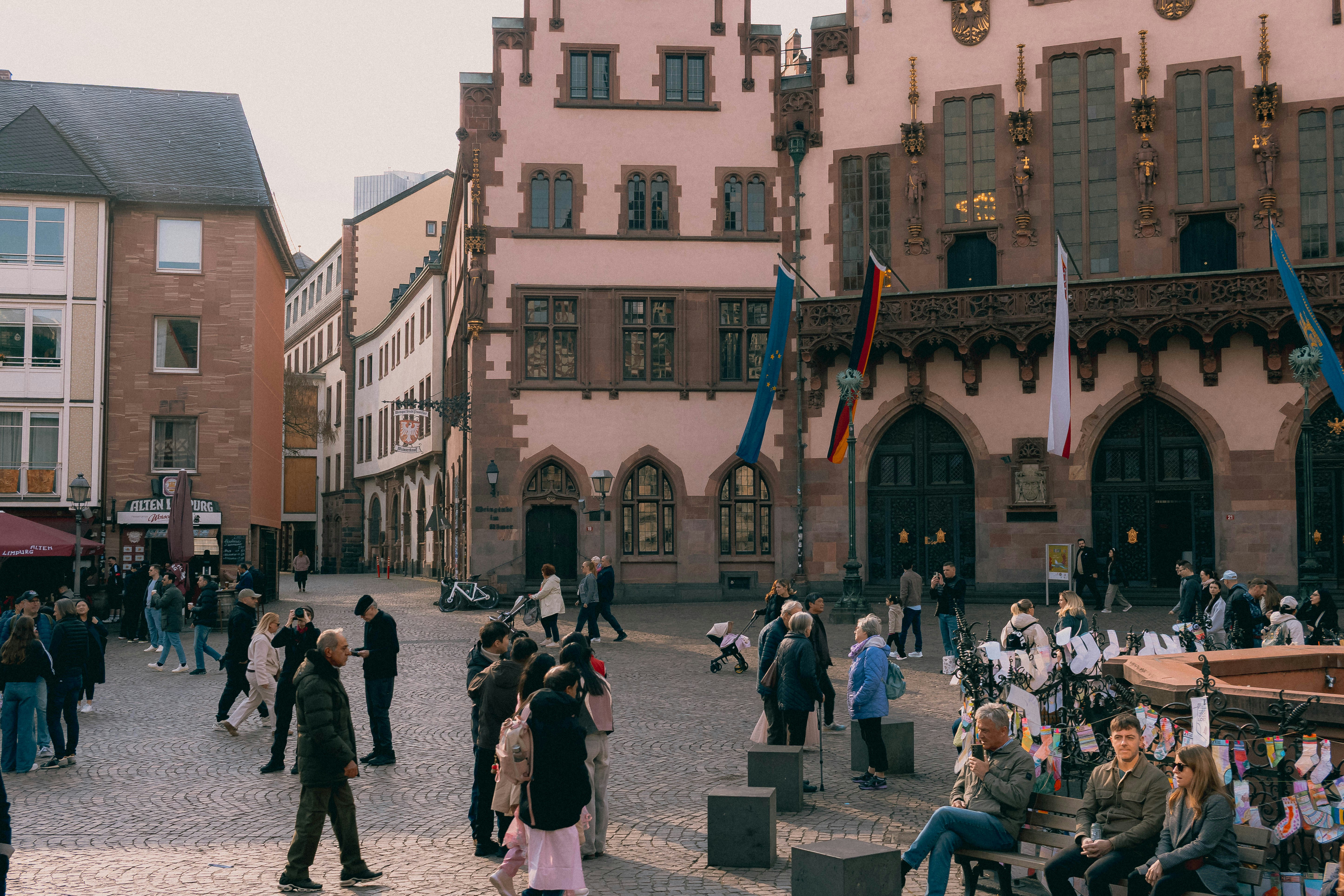 City Square in Focus: People, Flags, and Historic Facades