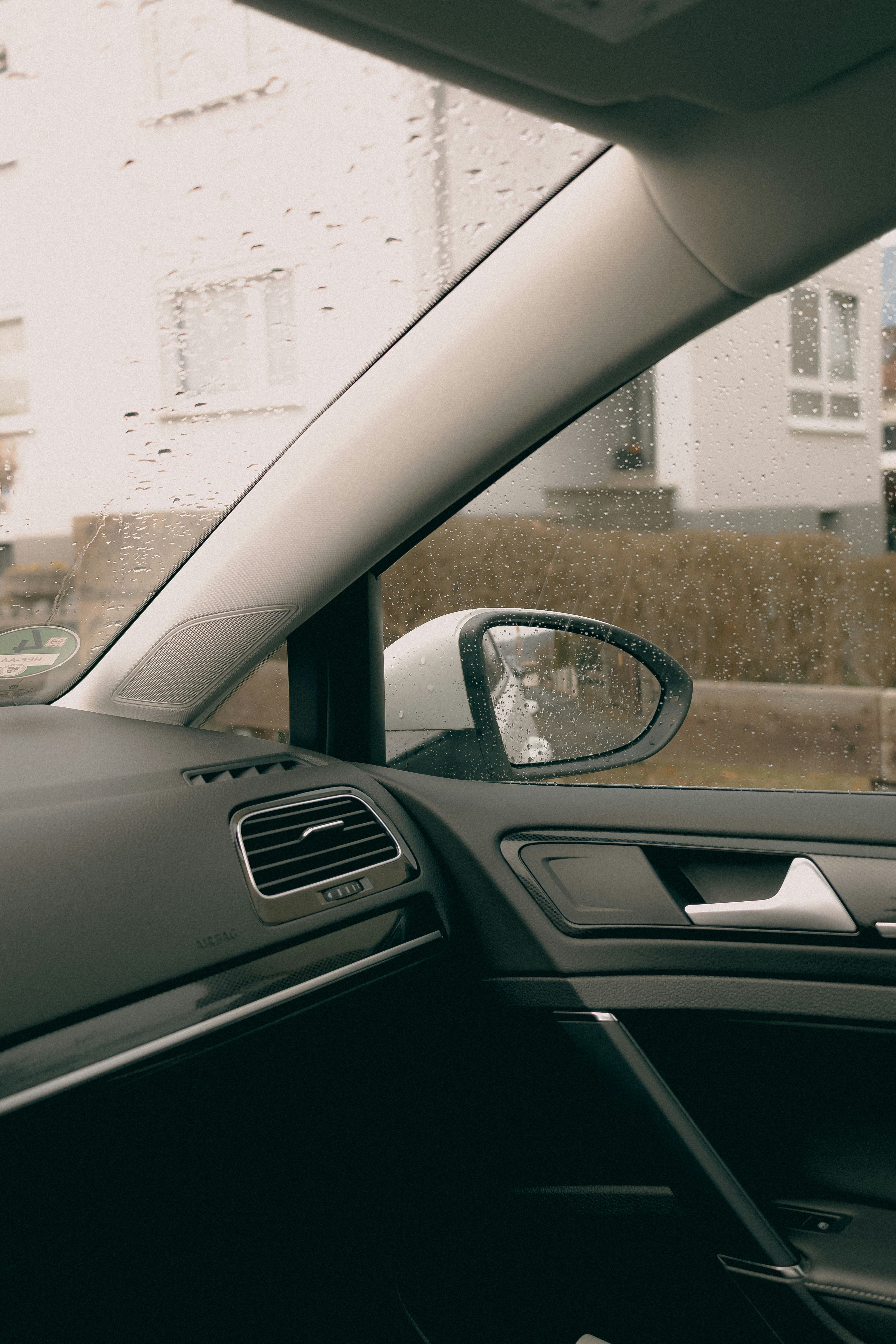 Rain-washed View Through a Car Window: Subtle Street Scene from the Passenger Seat