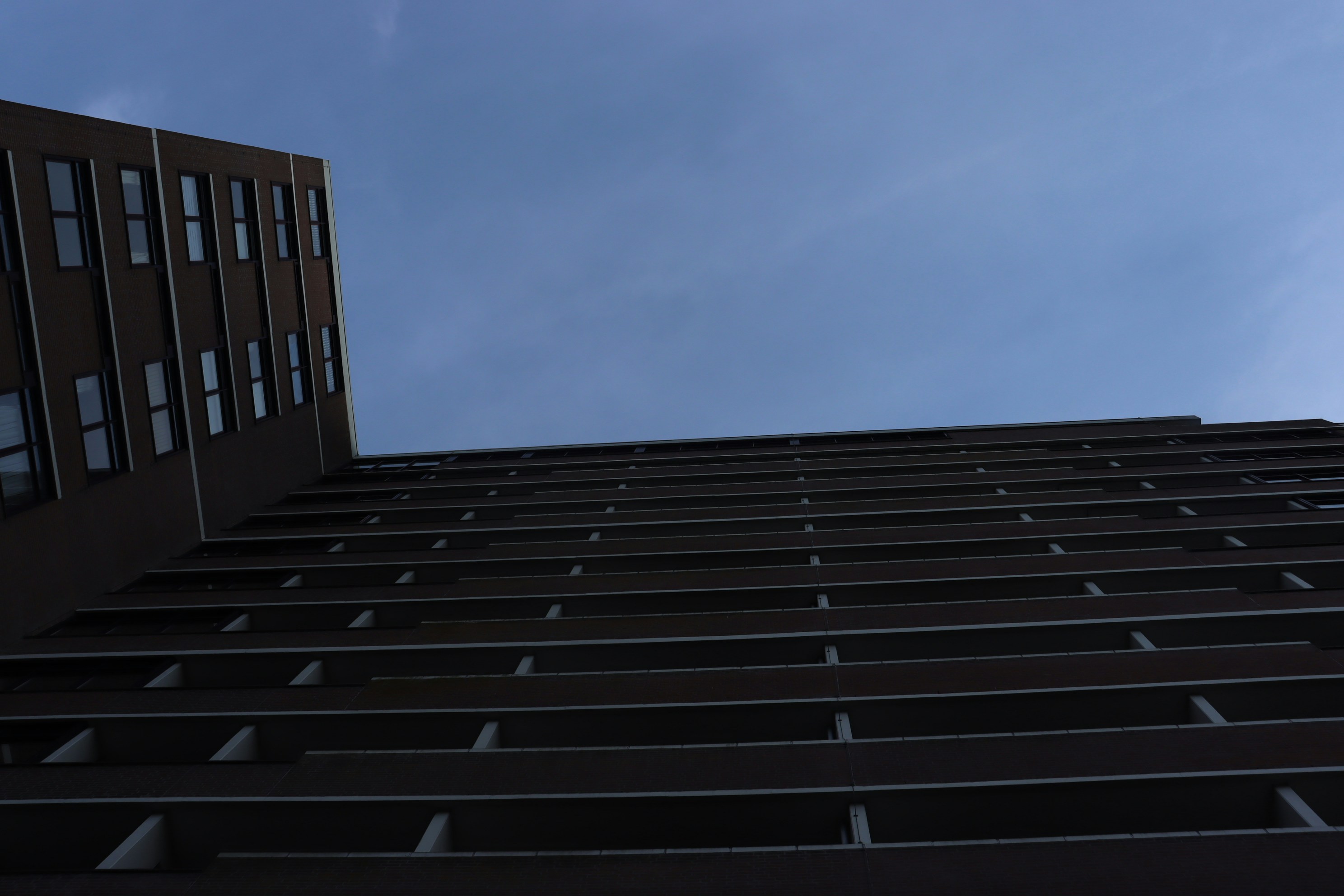 Upward Perspective: Stark Facade Against a Clear Sky