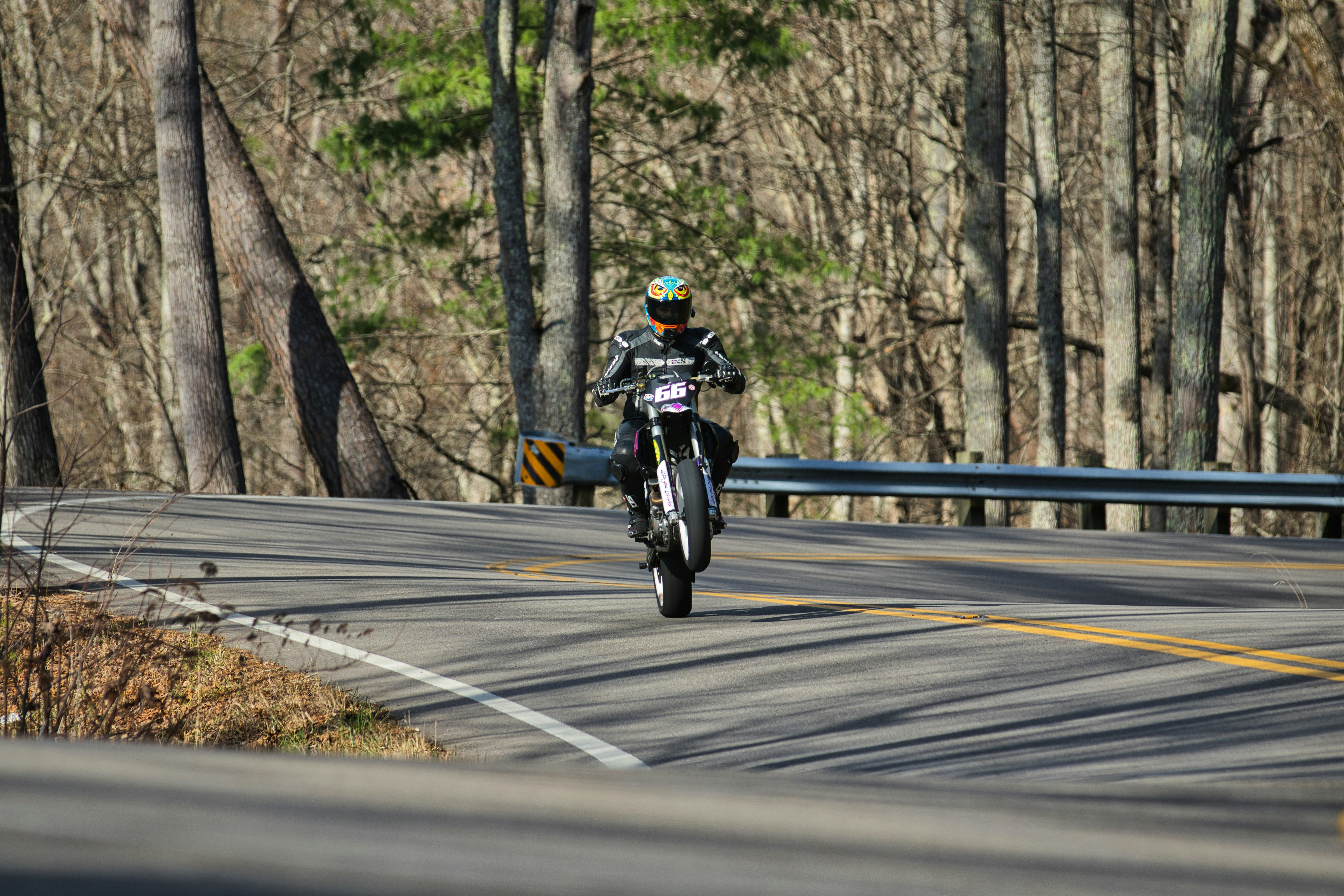 Mid-Road Rider: Focused Balance in a Curved Ascent