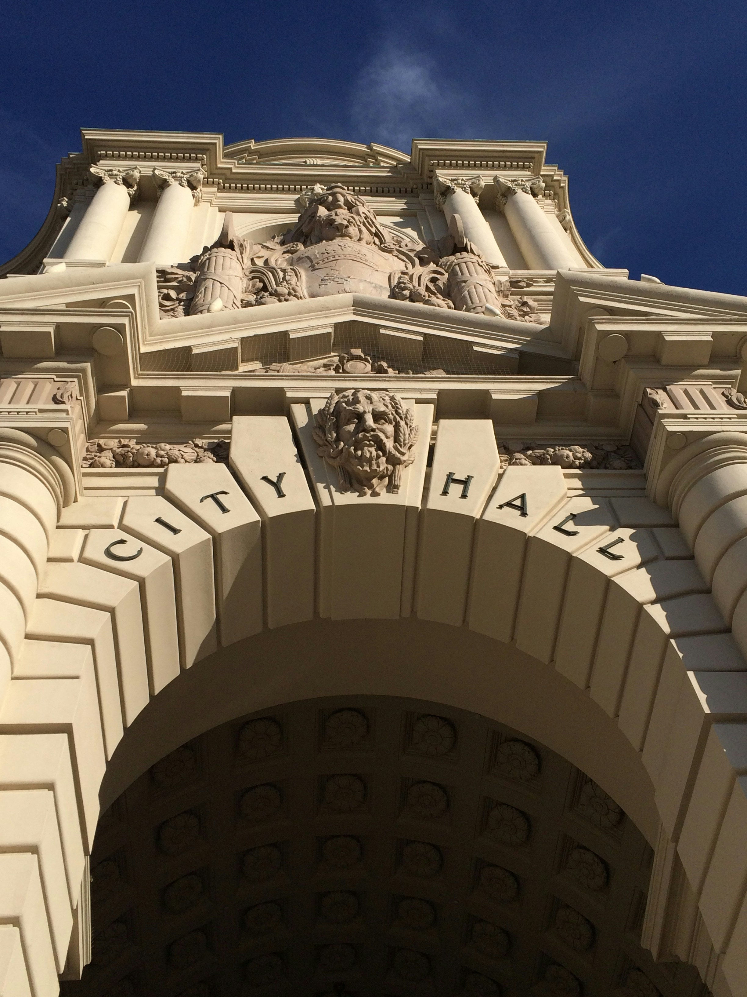 Ornate archway with "city hall" inscription