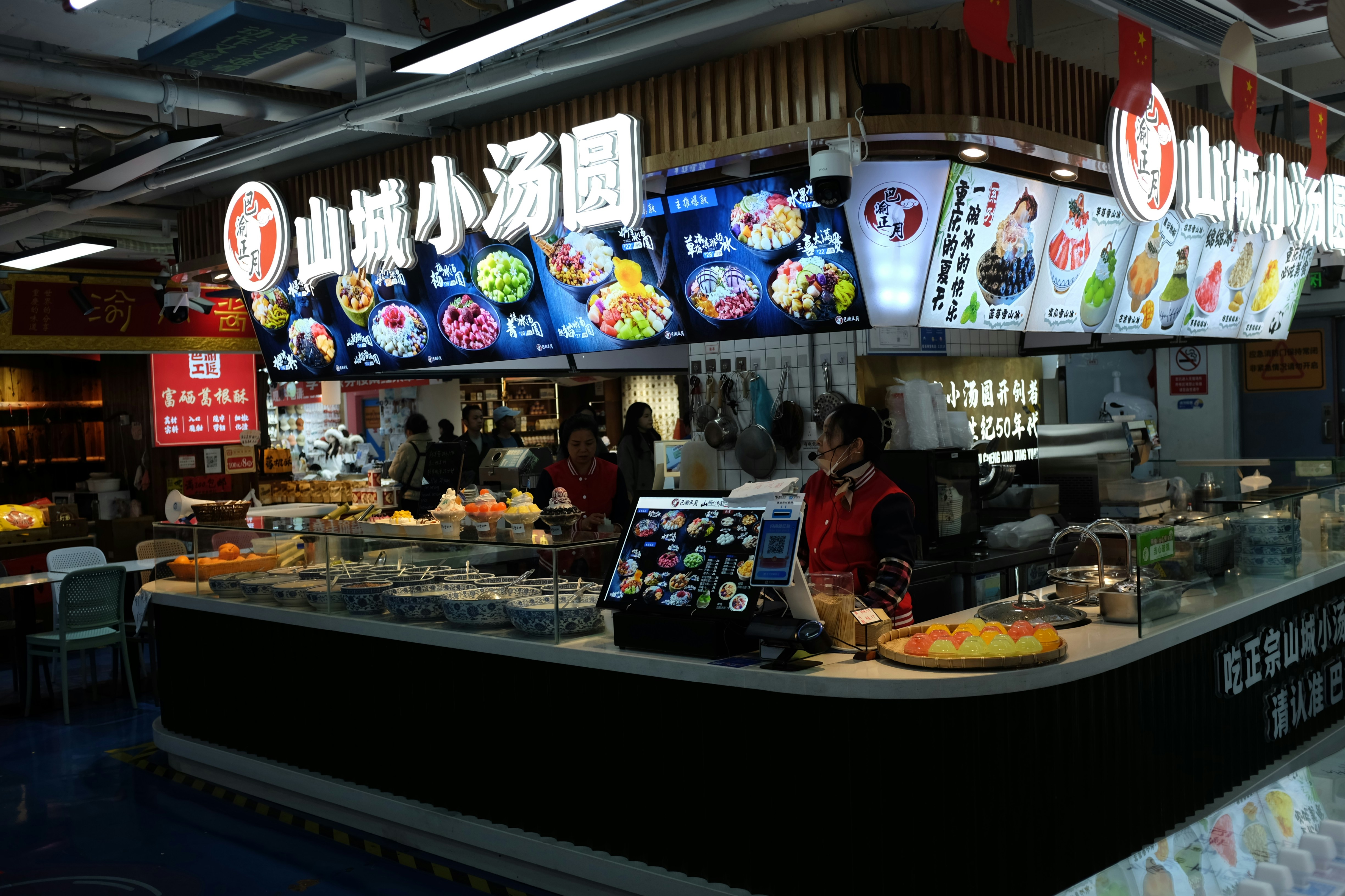 Culinary Carousel: A Bustling Street Food Counter Under Bright Signage