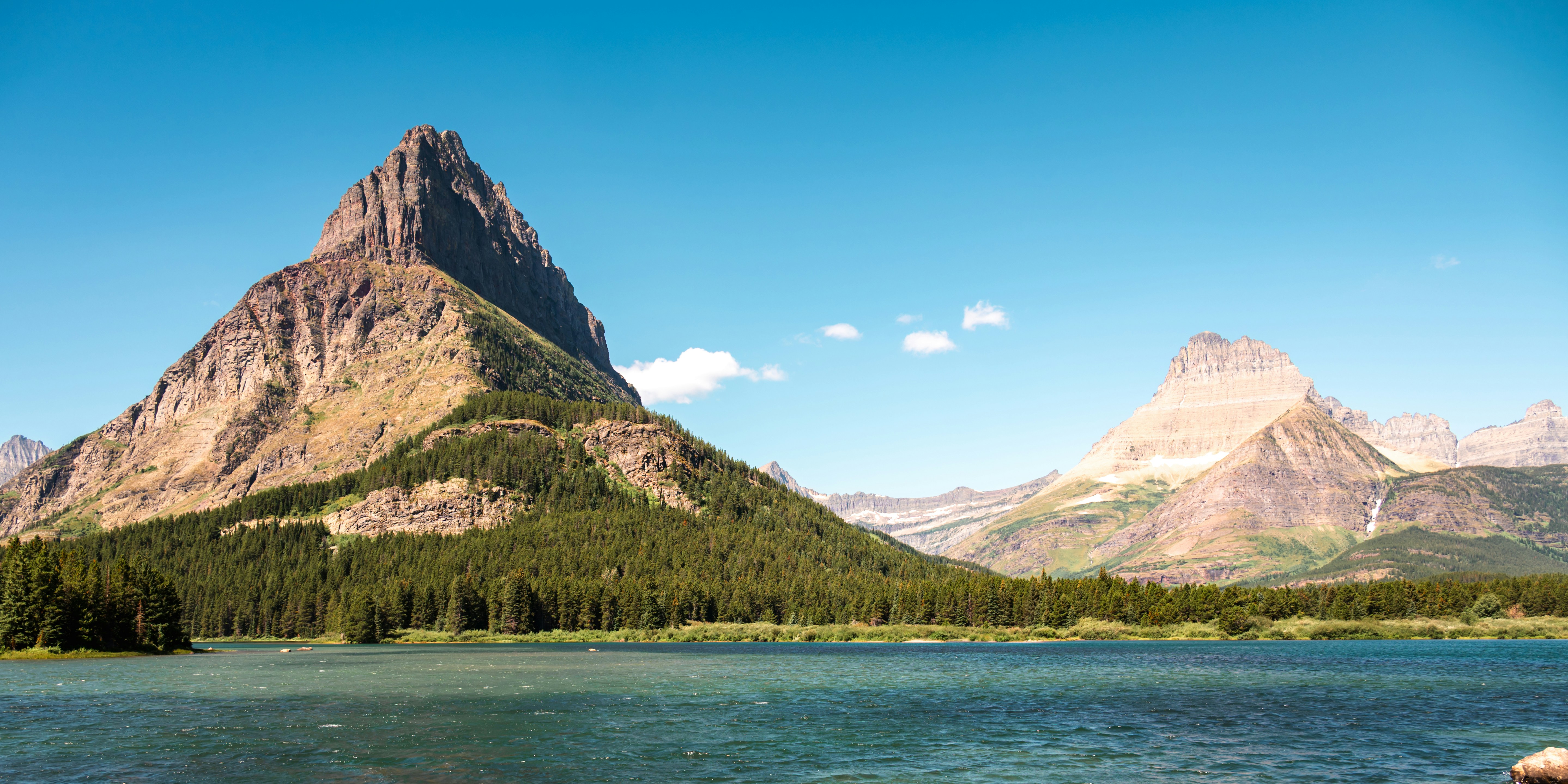 Towering Peaks Across a Serene River-Valley