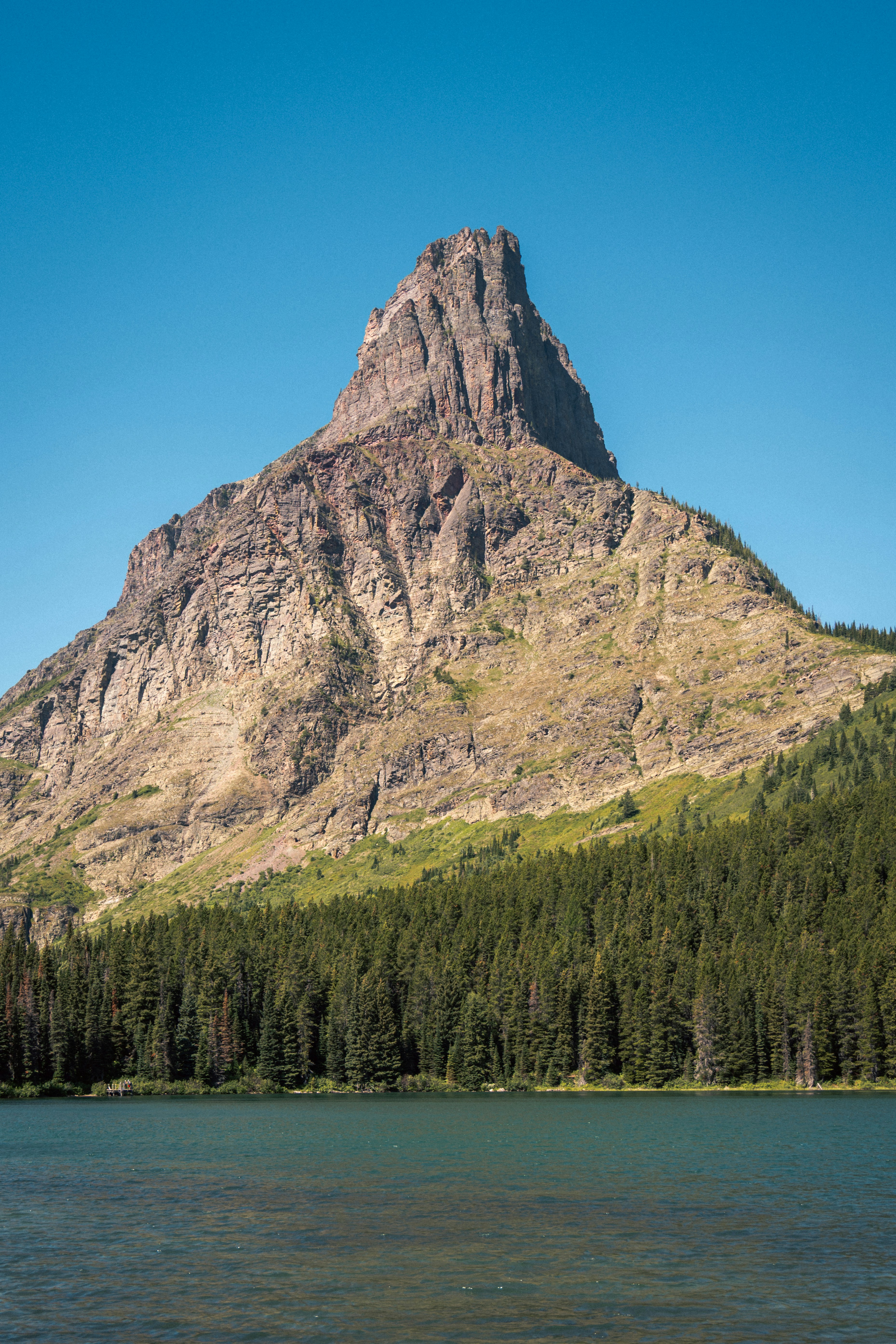 A Lone Granite Summit Rising Over a Needle-Needle Forest and Lake