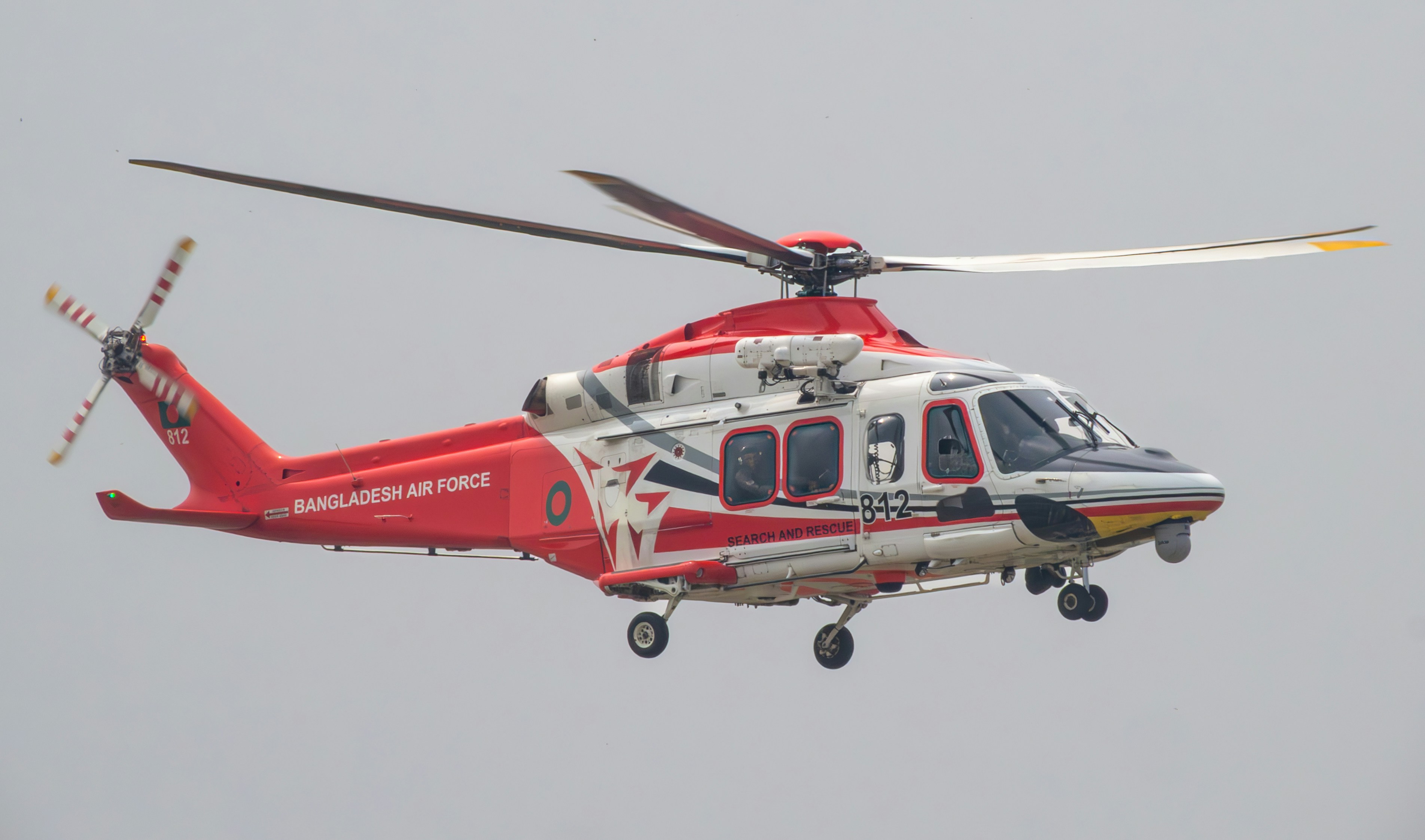 Red-and-White Mercy: Bangladesh Air Force Rescue Helicopter in Flight