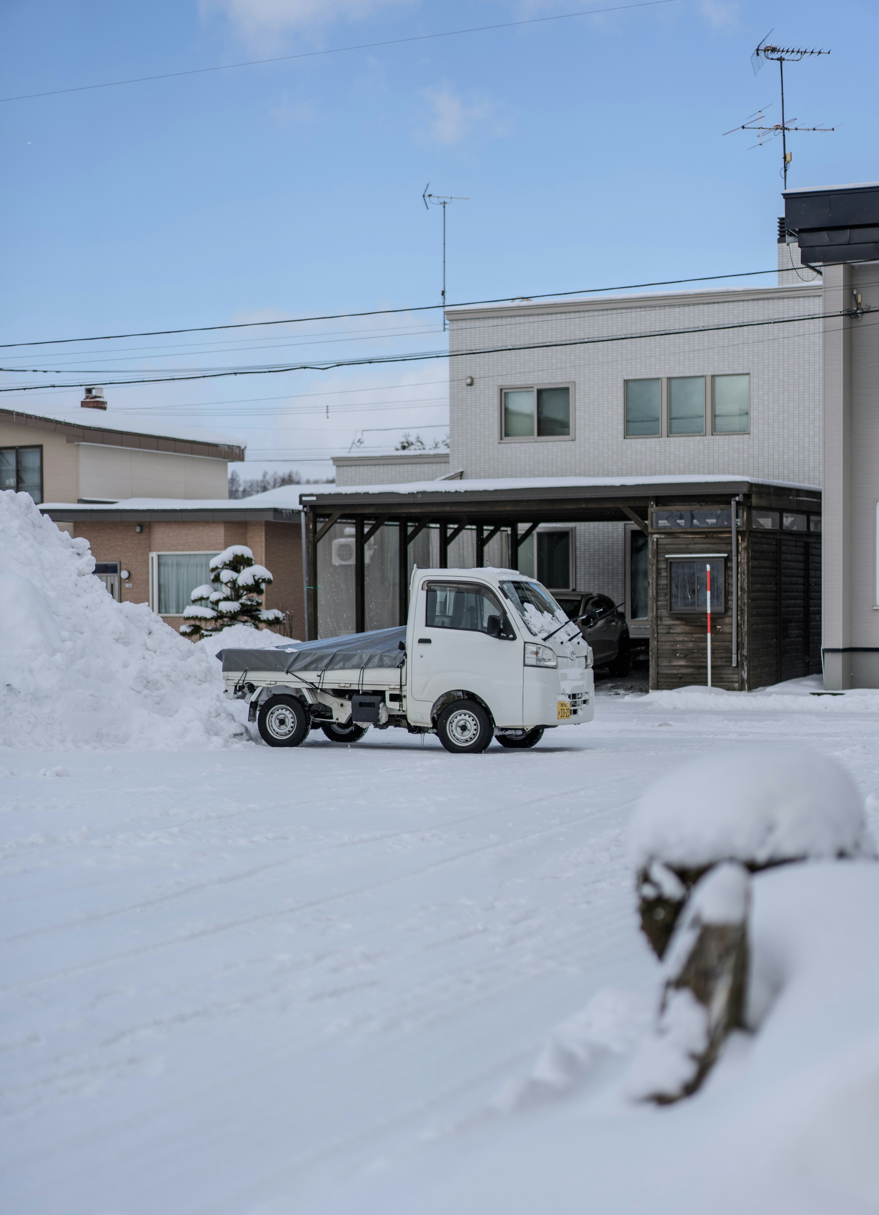 Snowbound Toyota: A Quiet Street Scene with a Small White Truck