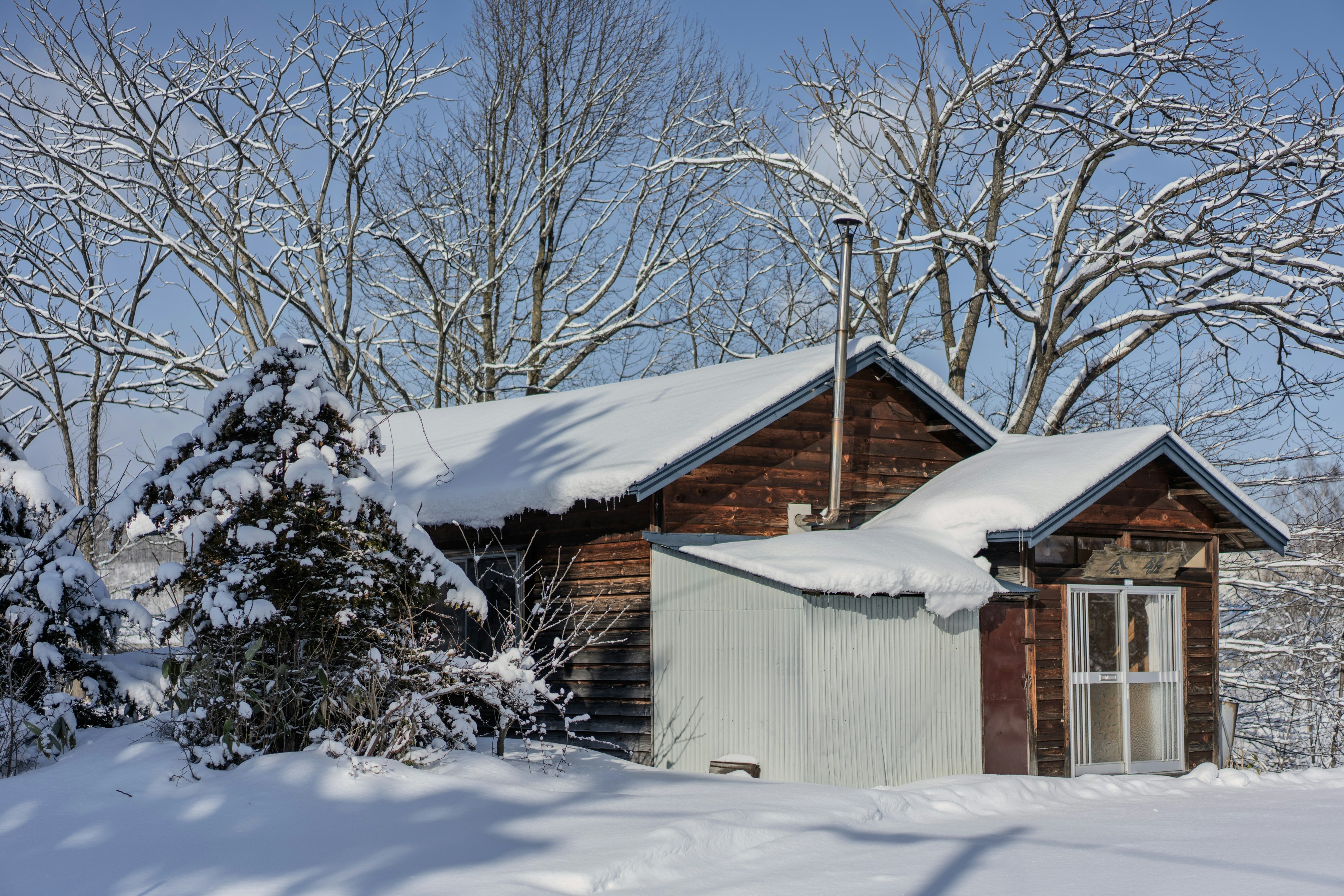 Snowbound Cabin with Icicle Trained Roofs Under Quiet Winter Sky
