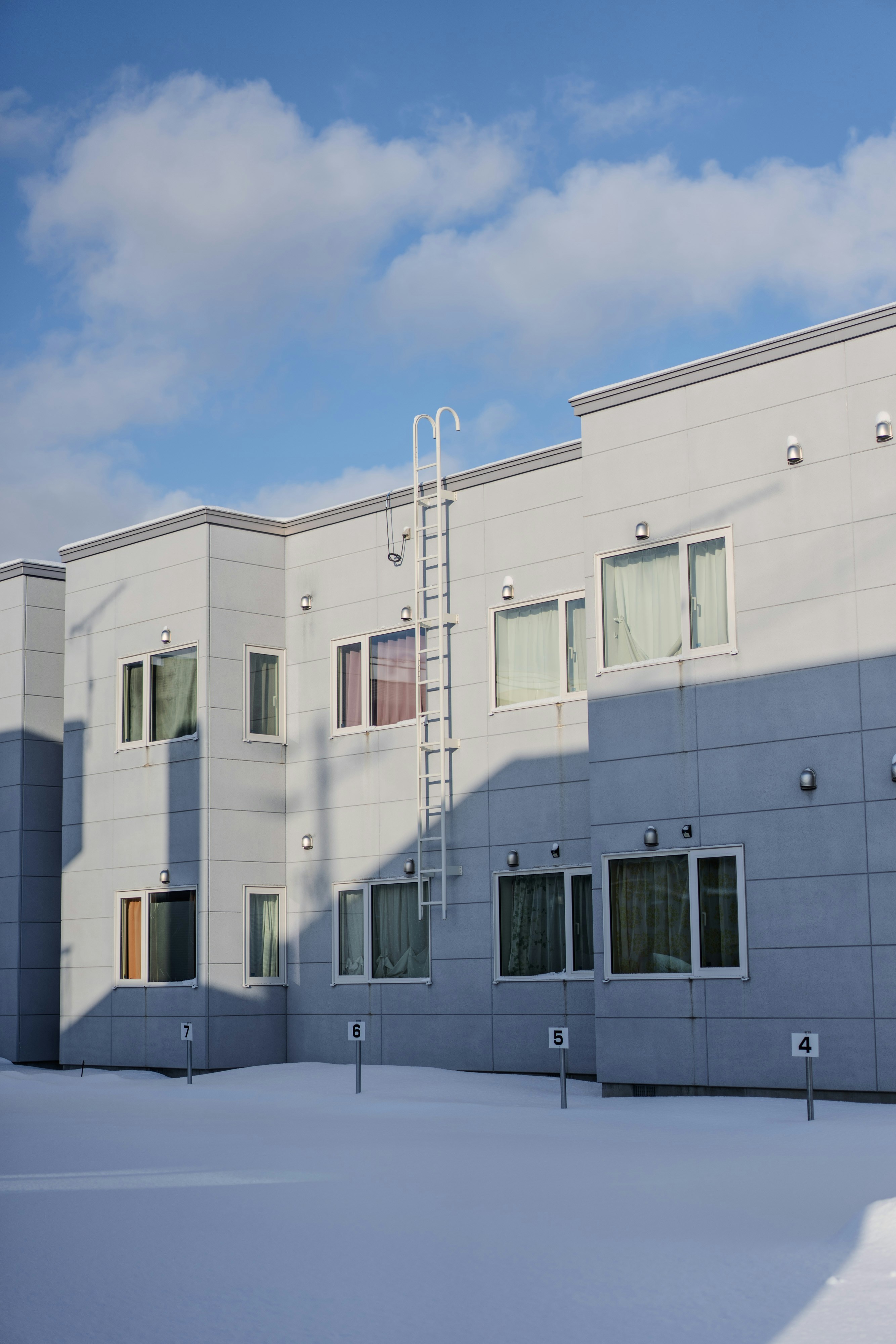 Snowbound Apartment Row Under a Bright Nordic Sky