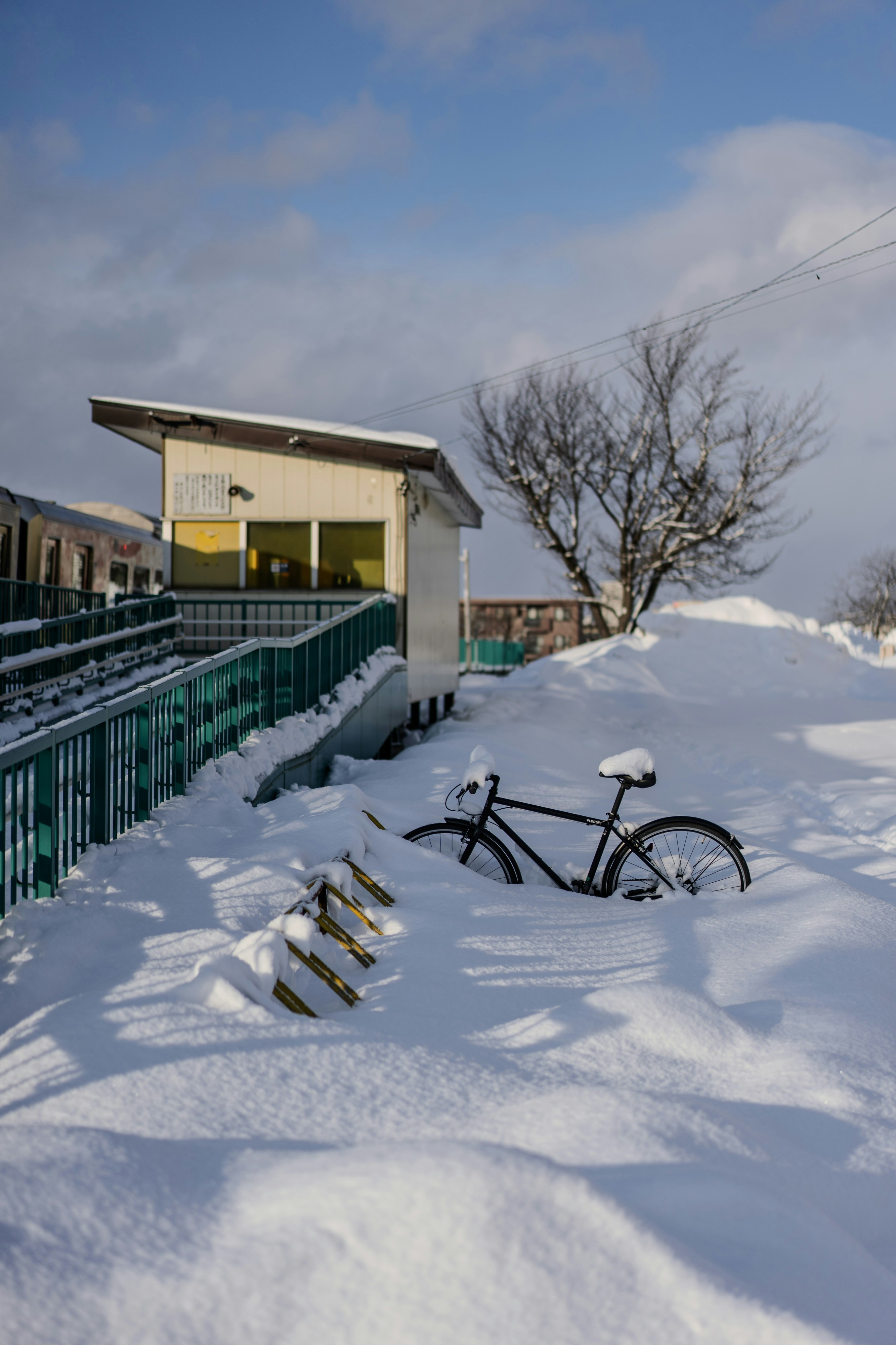 Snowbound Bicycle by a Quiet Station