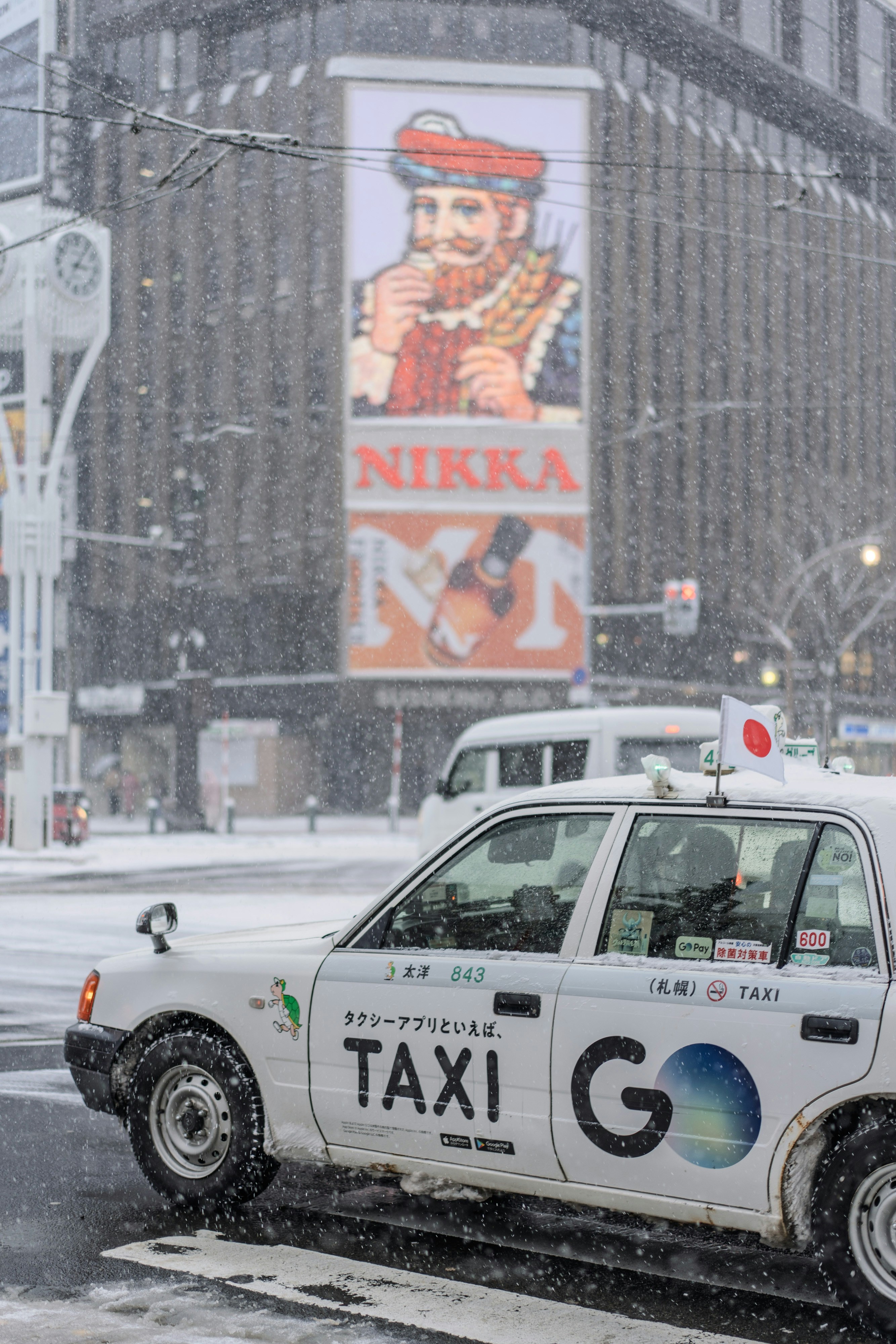 Taxi in Snowfall Under a Neon Mural