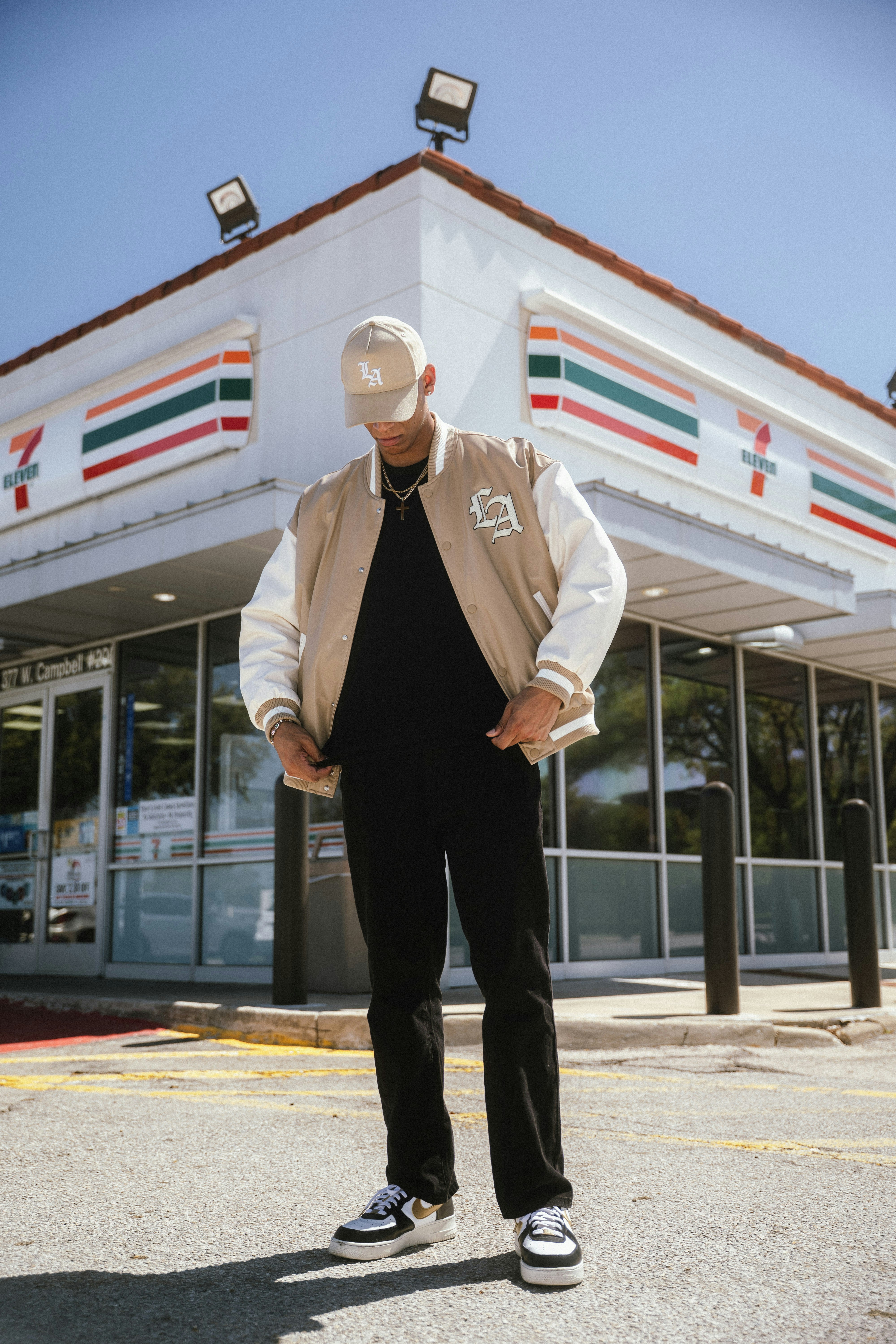 Midday in a Neon-Striped Quiet: A Streetwear Moment Outside a Retro 7-Eleven