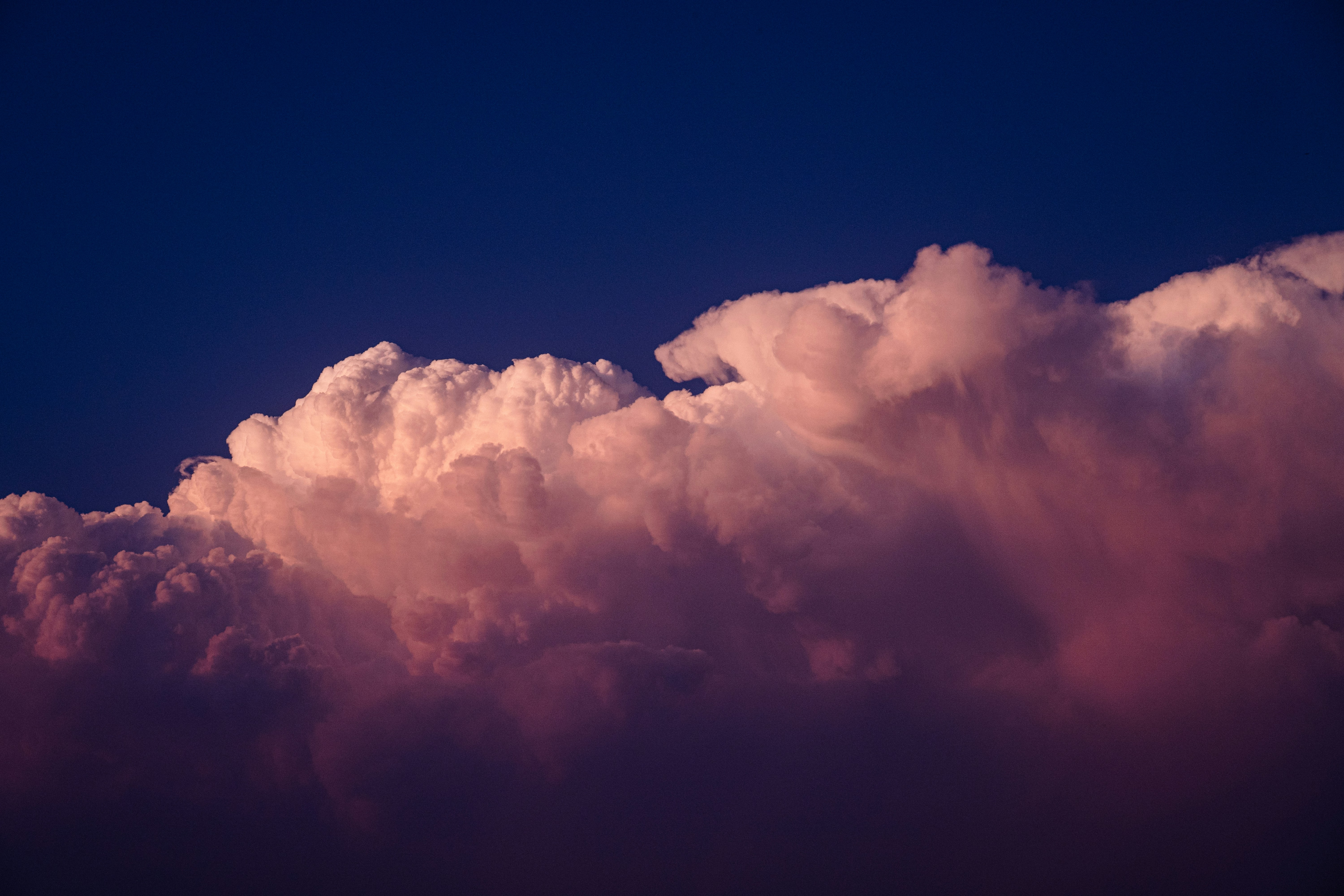 Aurora of Dusk: A Velvet-Blue Sky Over Pink-tinged Clouds