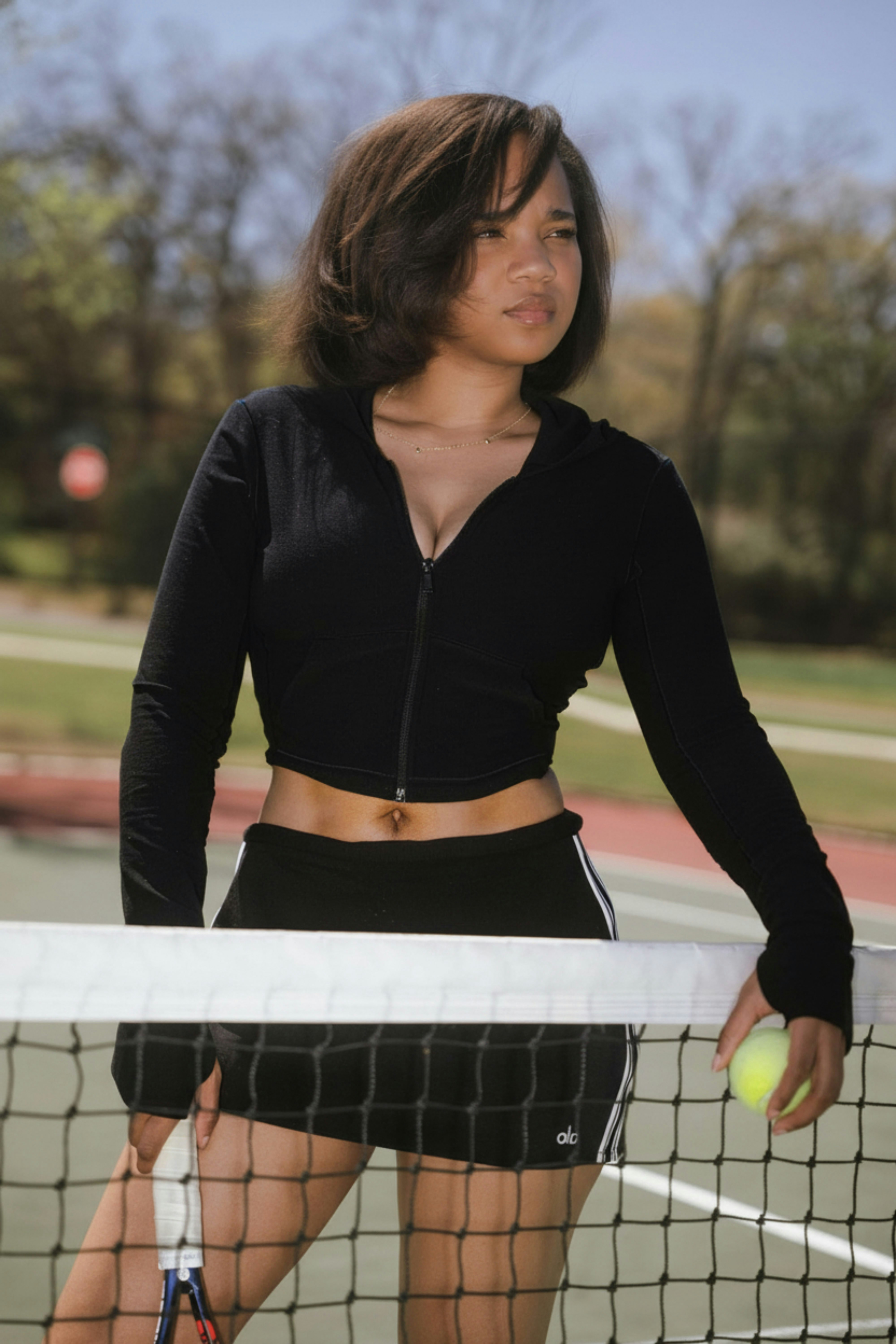 Netted Focus: A Tennis Serving Moment in Afternoon Light