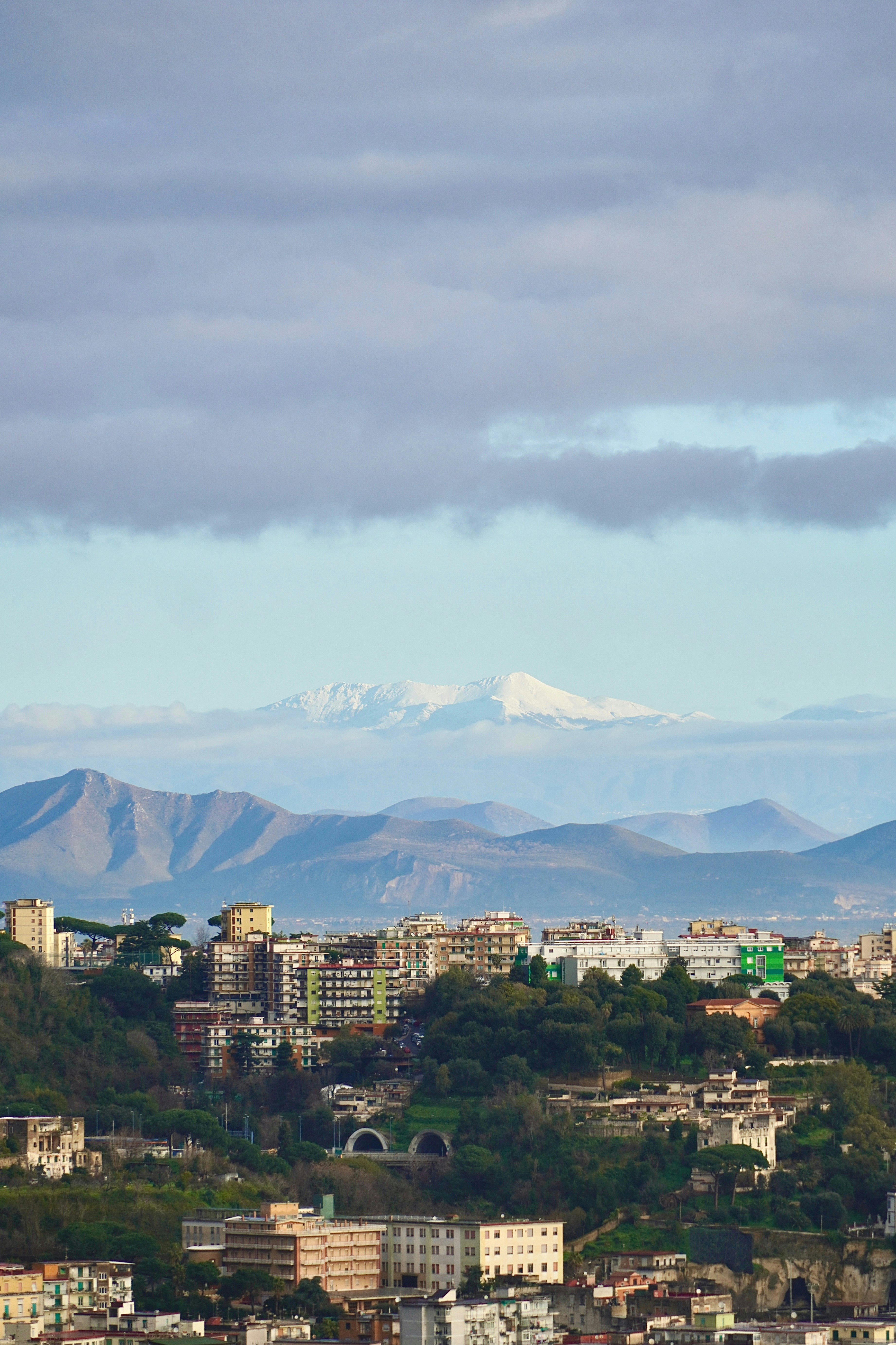 High-Rues and Snow-Capped Peaks: A City Fringed by Mountains