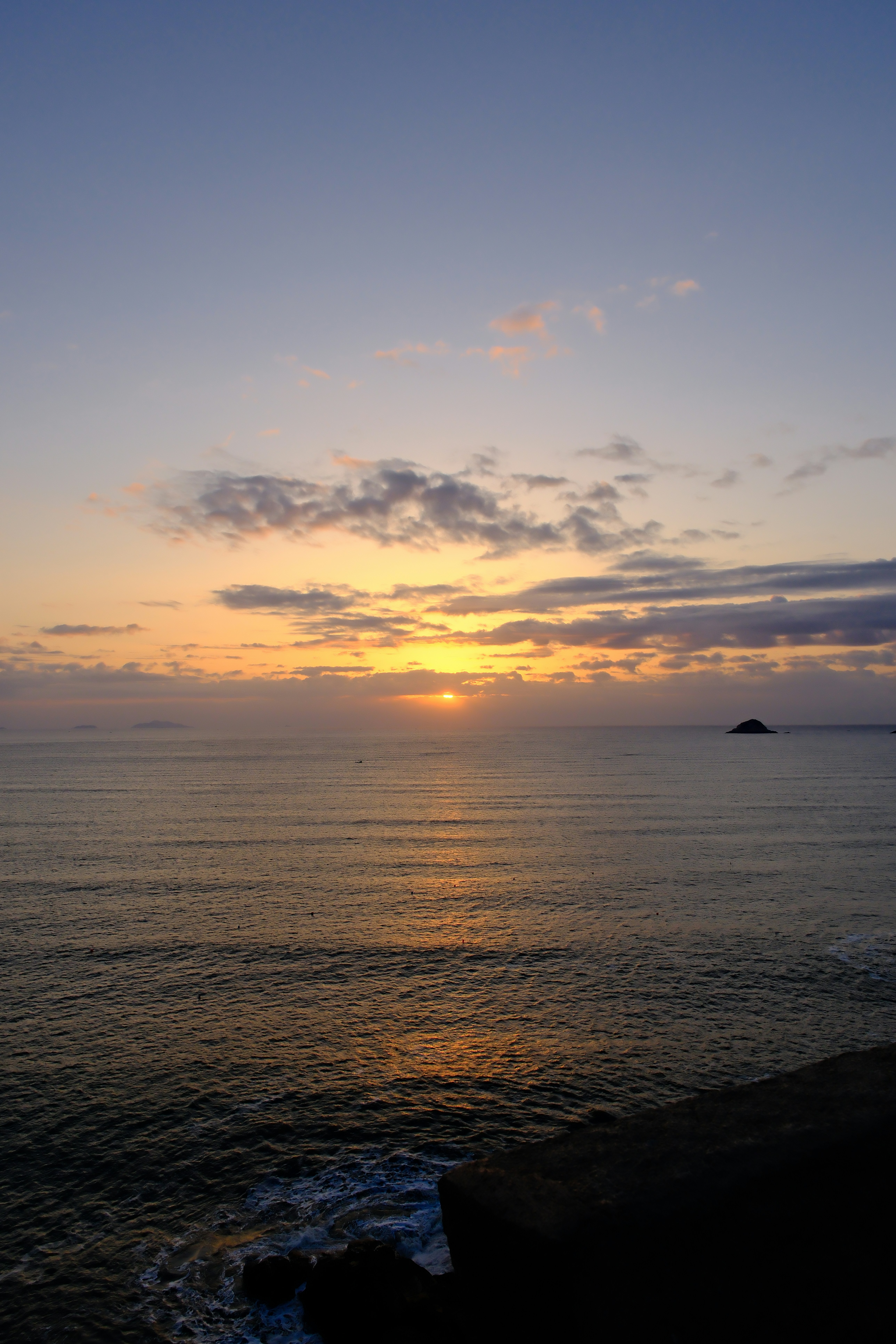 Sunset on a Quiet Sea: Golden light over calm waters