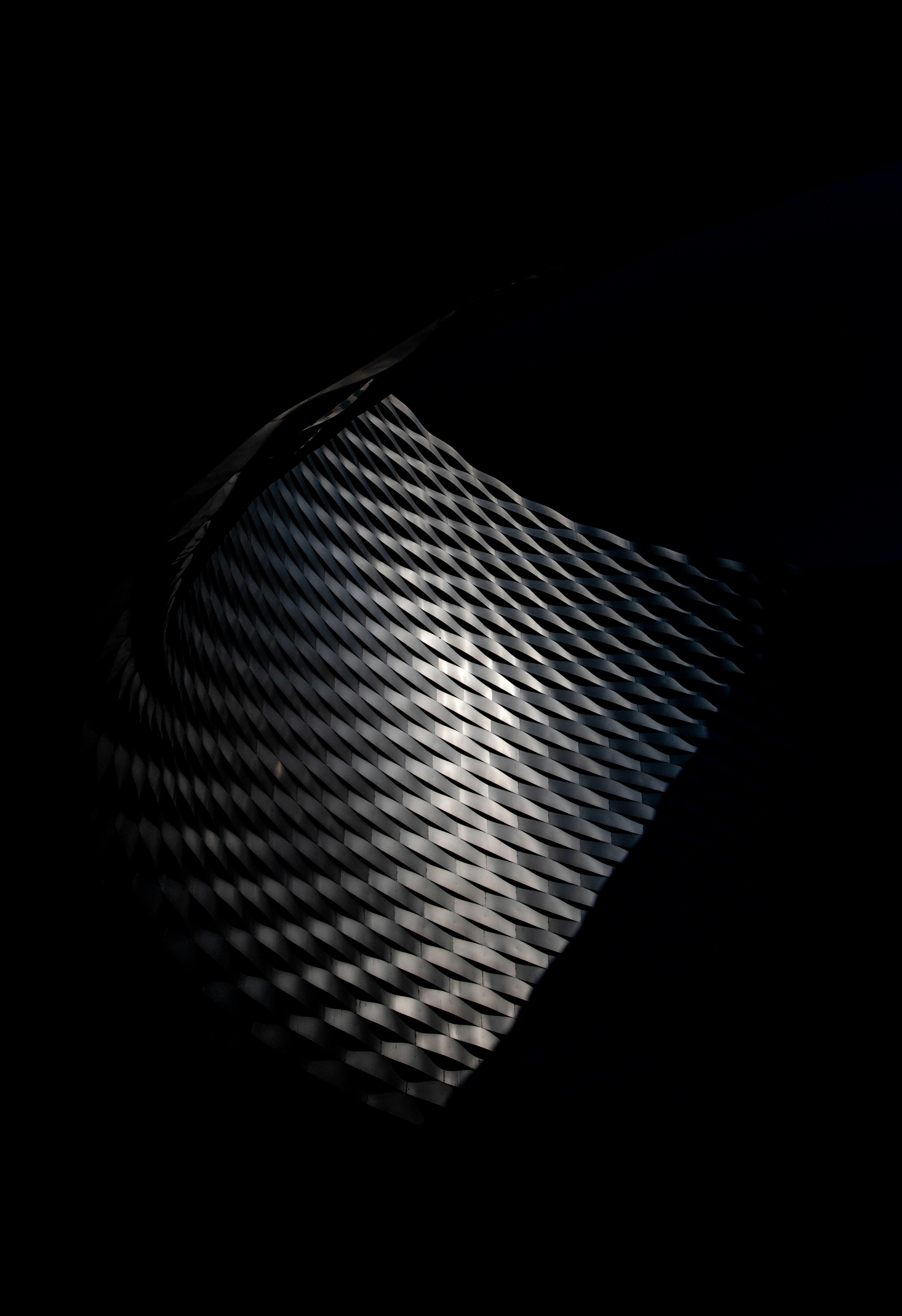 Woven Light: A Close Look at a Metal Mesh in Shadow