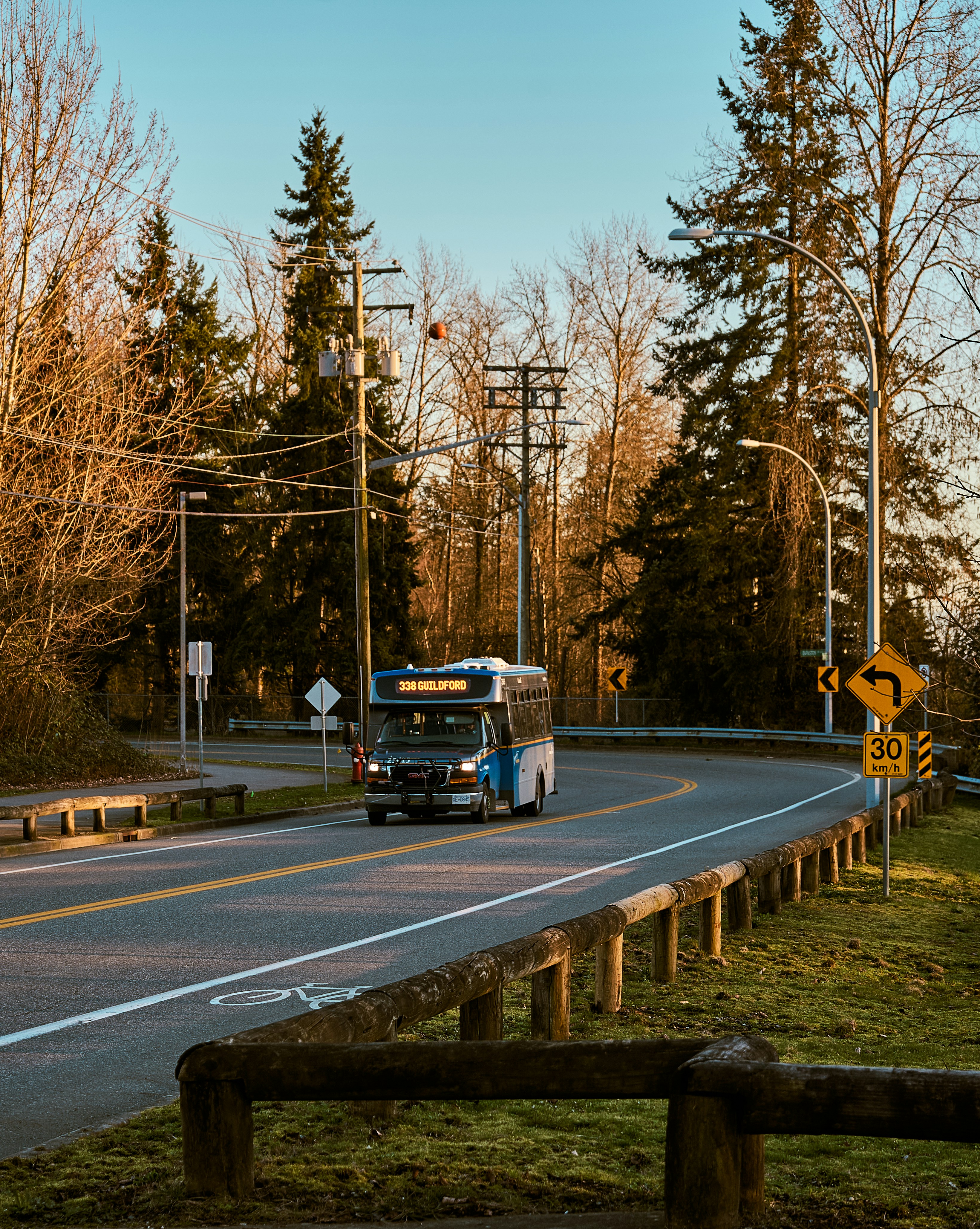 Rural Route at Golden Hour: A Bus Bends Through Quiet Streets