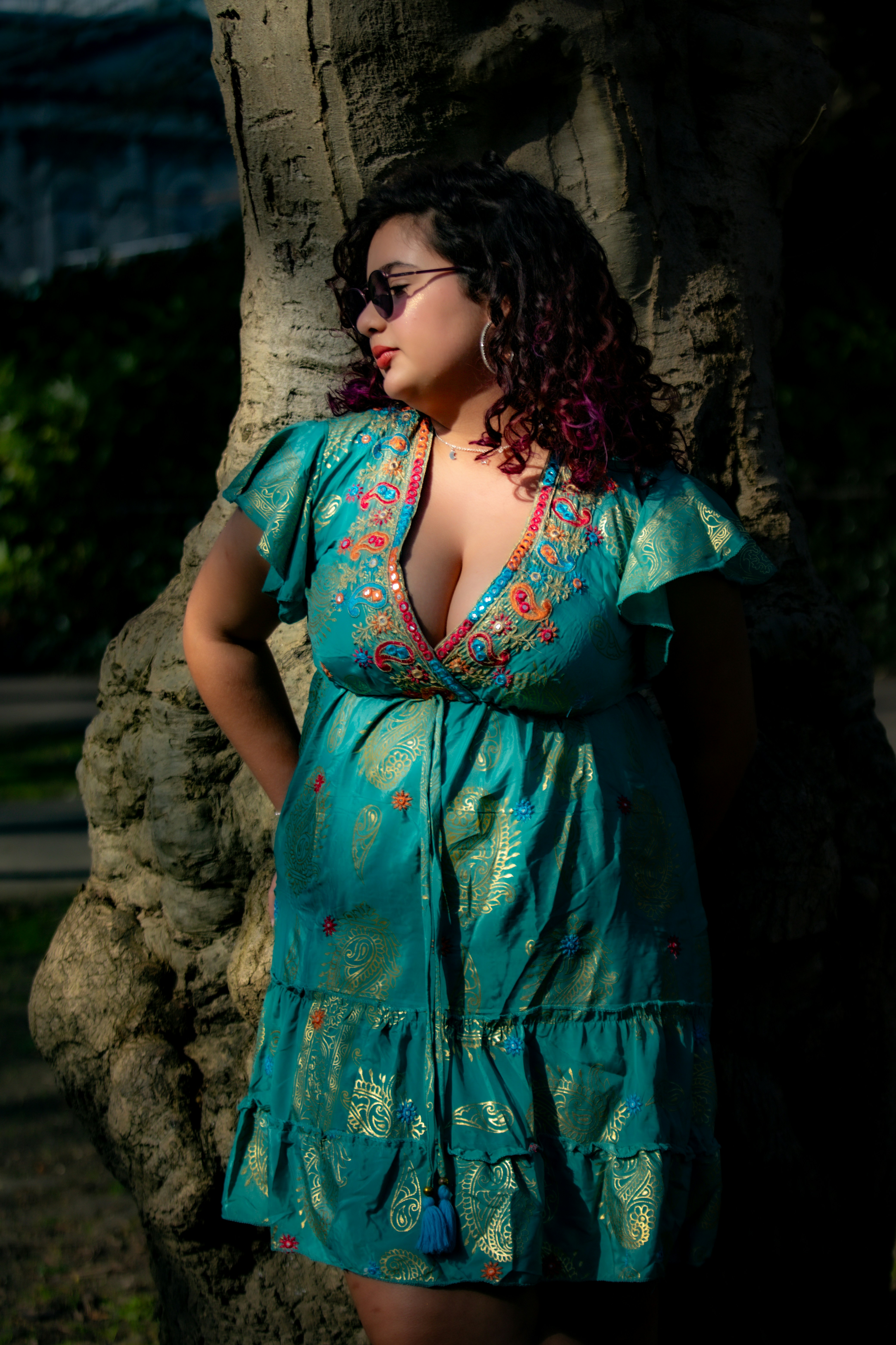 Teal echo under the tree: a portrait in dappled light