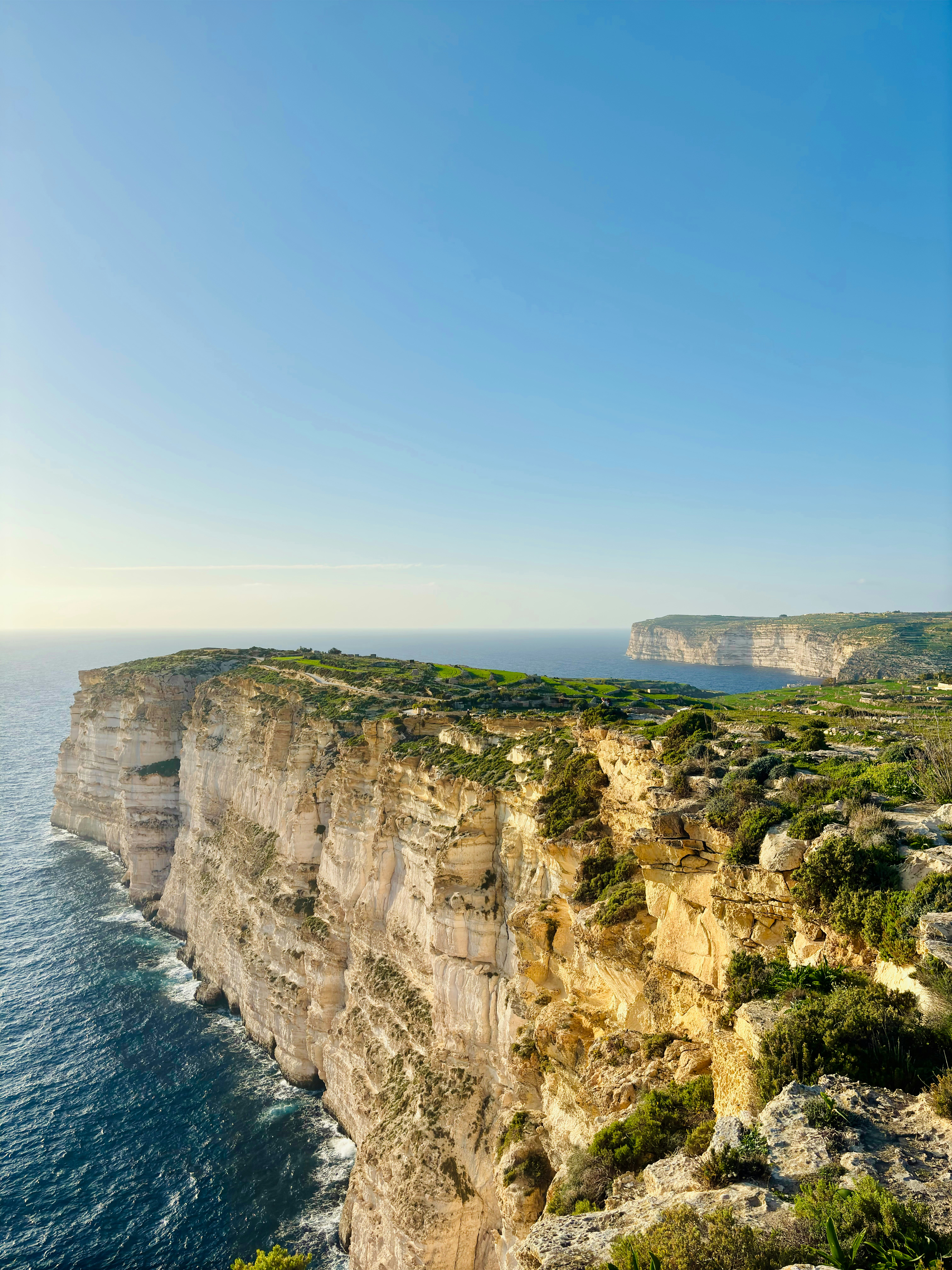 Clifftop Edge: Sunlit Limestone Facades Over the Sea