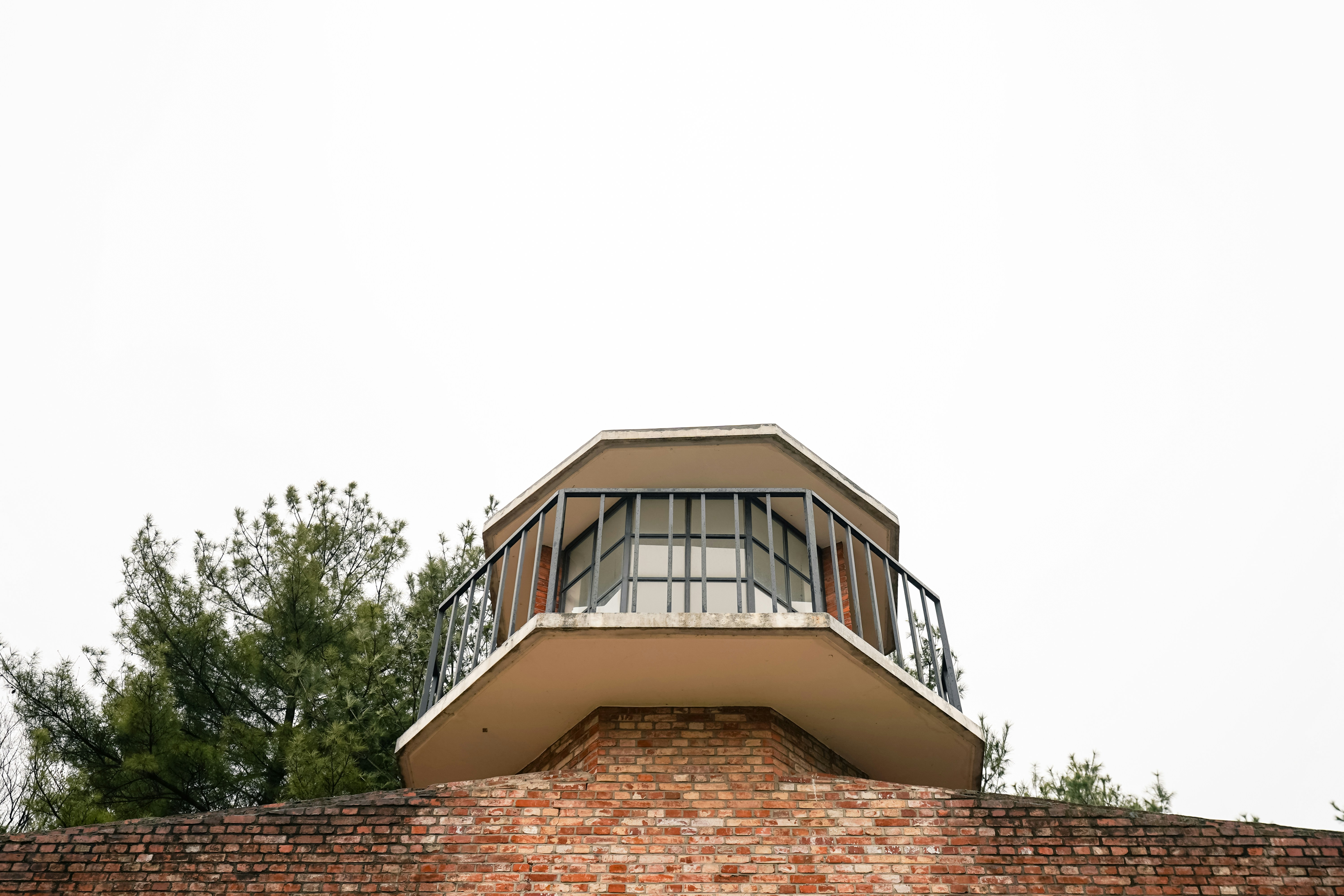 Balcony Over Brick Hex: A Mid-Century Lookout atop a Brick Wall