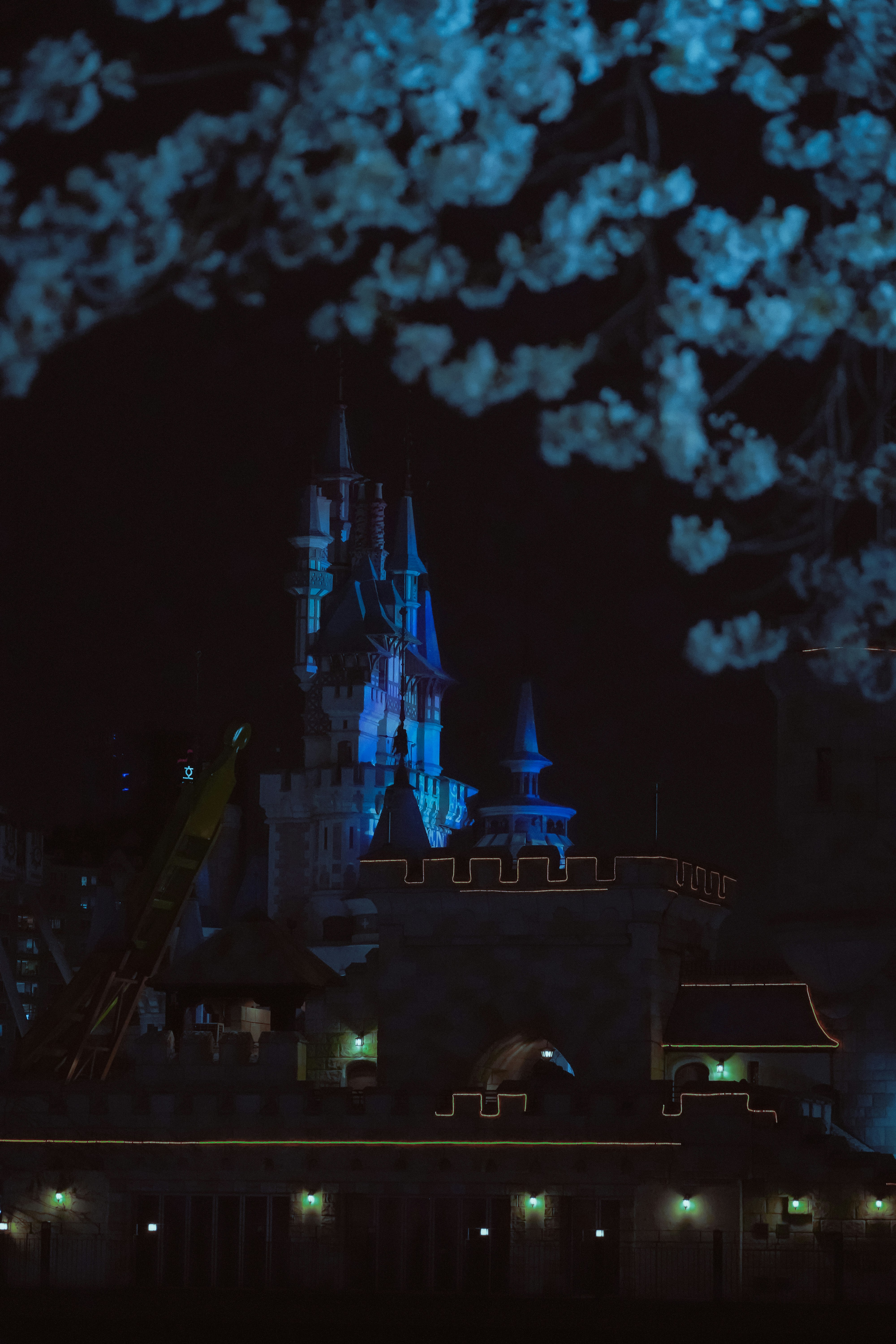 Moonlit Castle: Neon Blue Spires Beneath Blooming Night