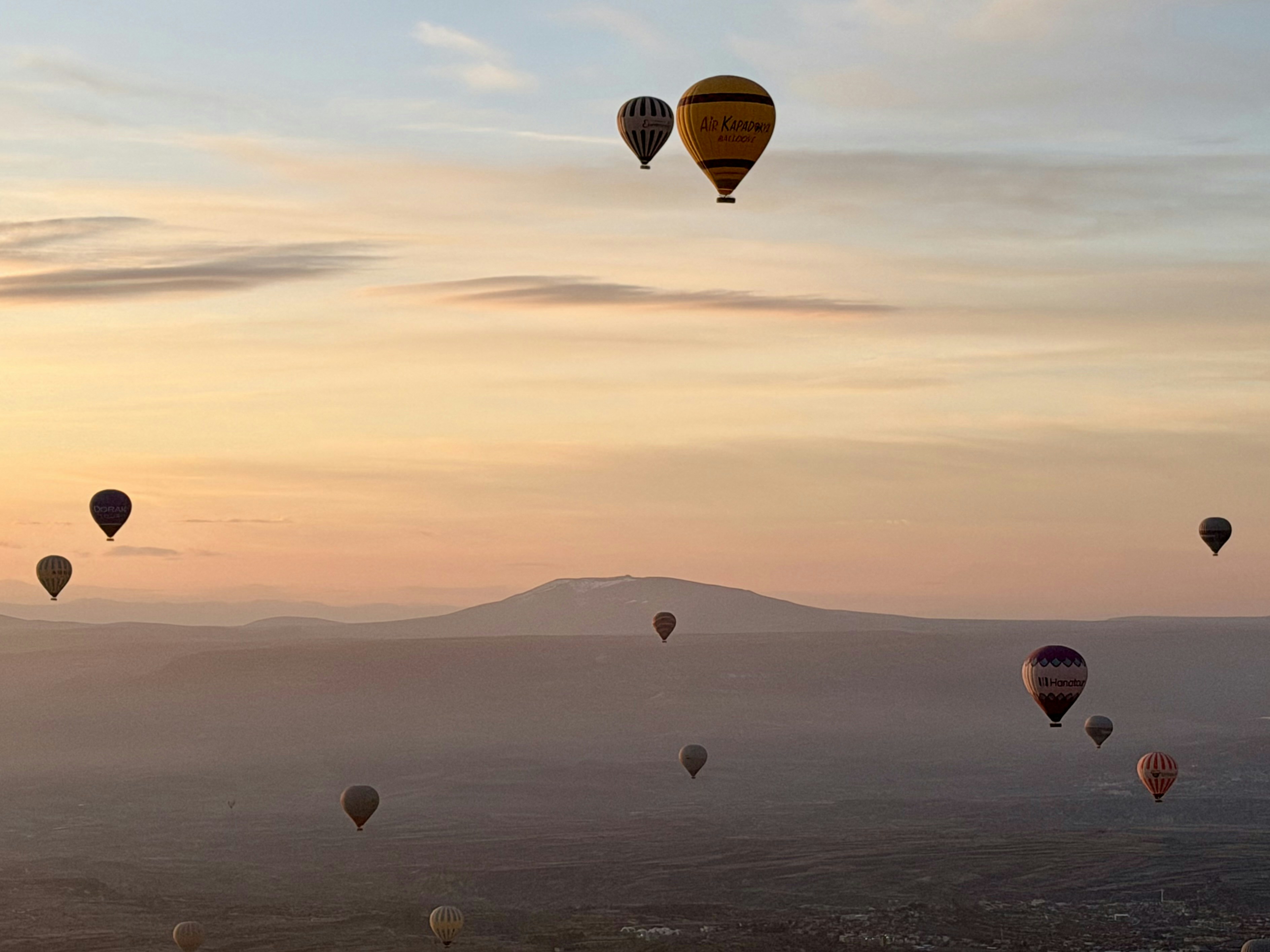 Dawn Above the Valley: Balloons in Quiet Ascent