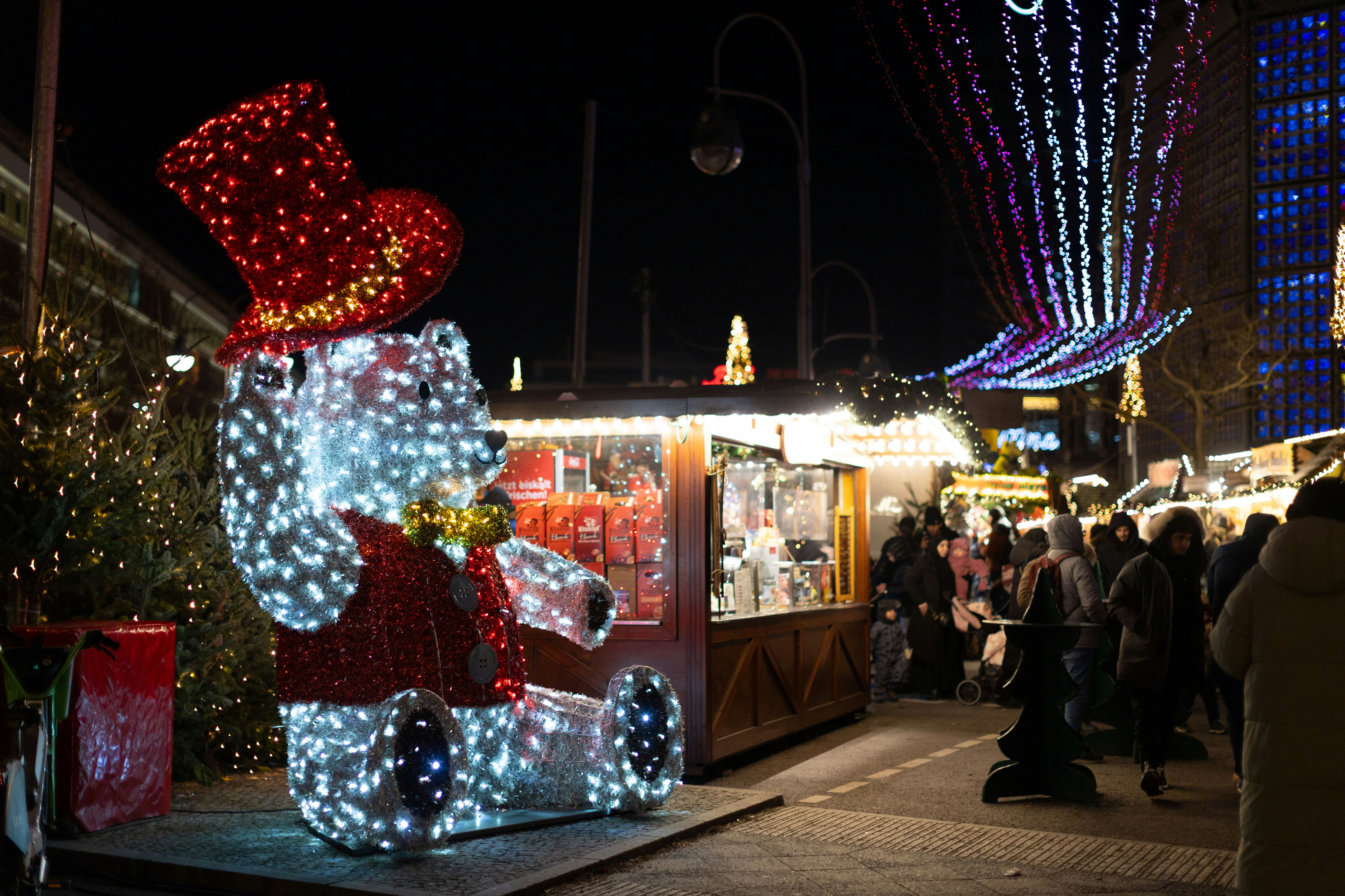 Icy Parade: A Lighted Teddy Bear Guarding the Festive Market