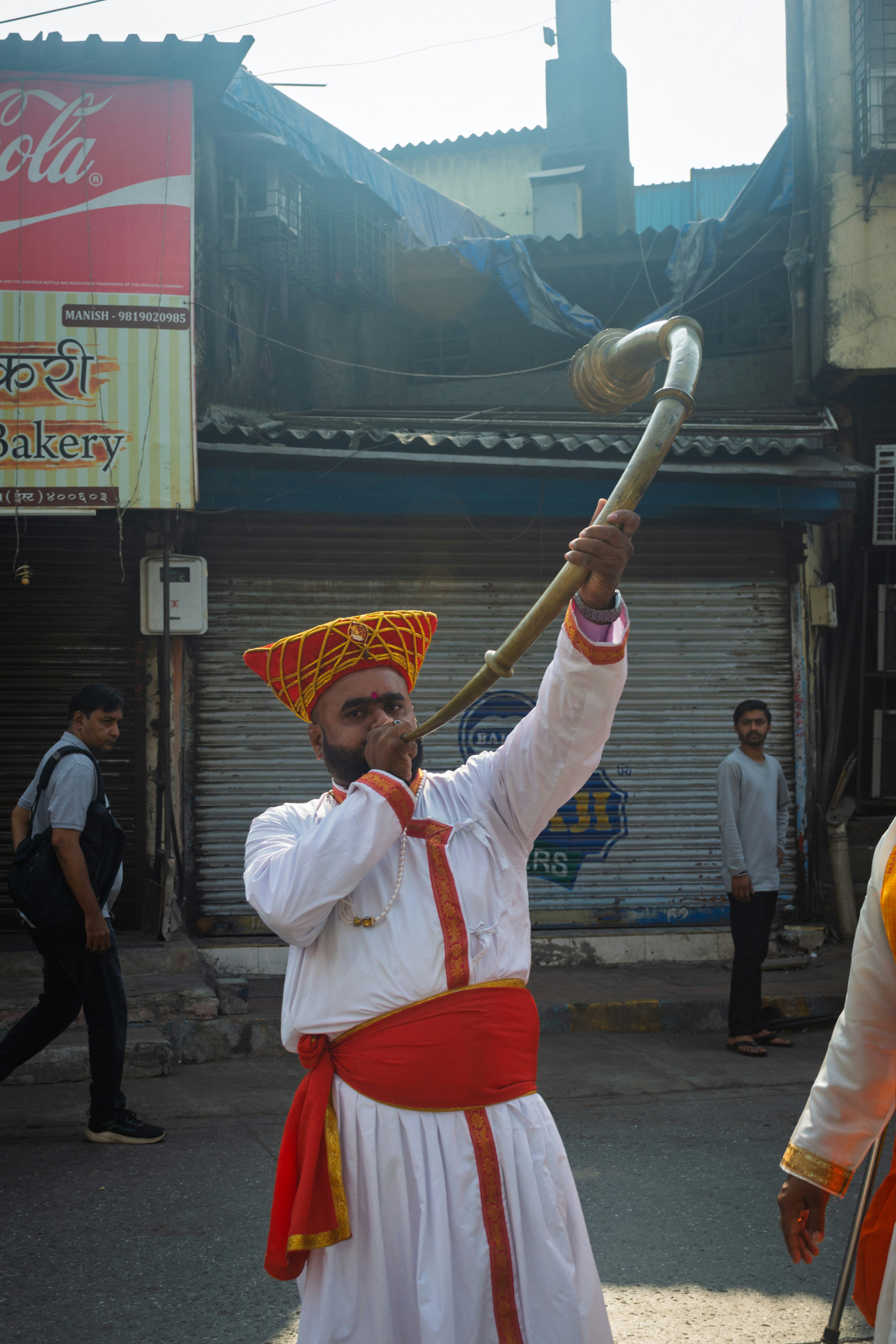 Mirthful Blare: A Street Brass Solo Under a Turbaned Stream of Light