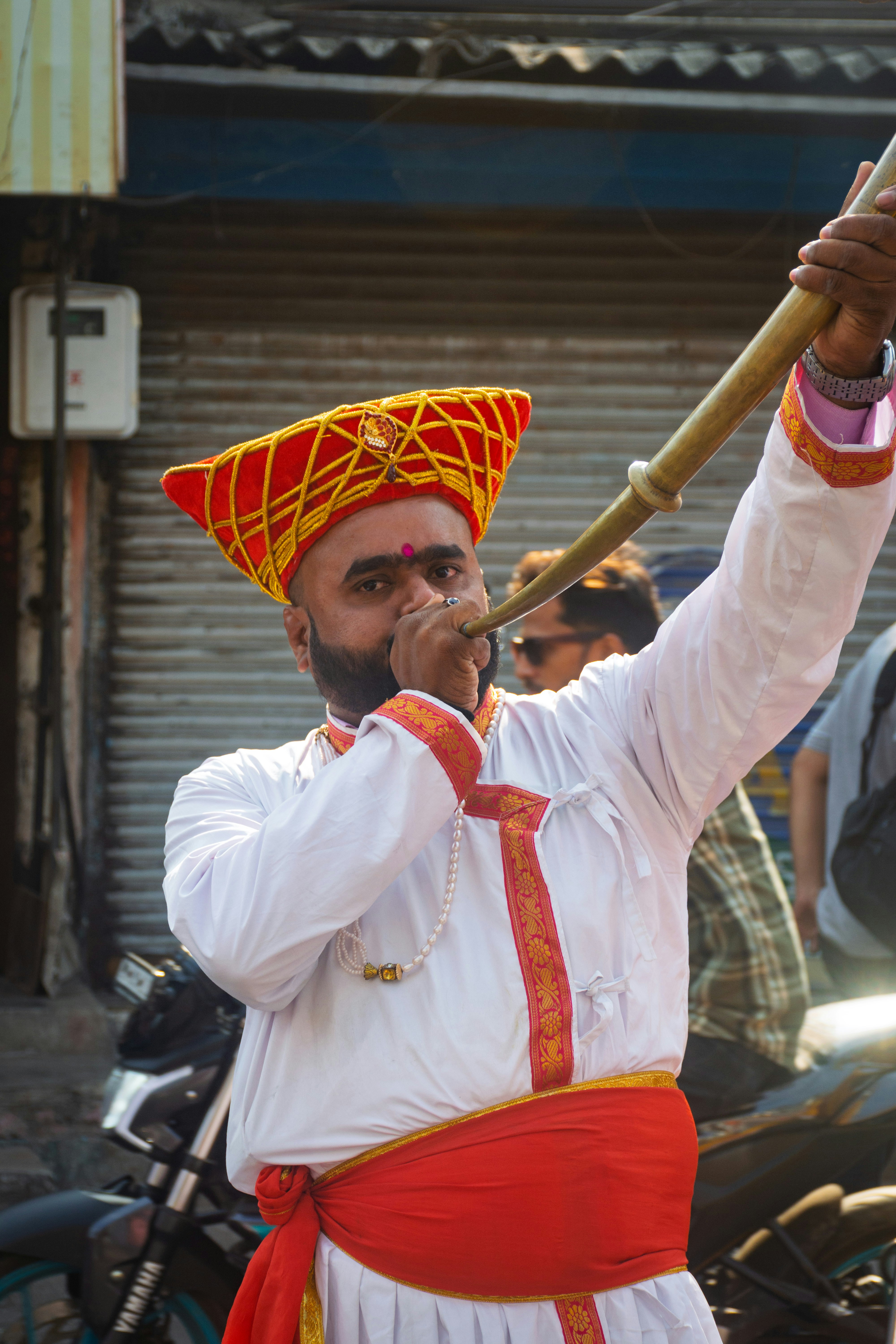 Dhol Riff: A ceremonial horn salute under a festive turban