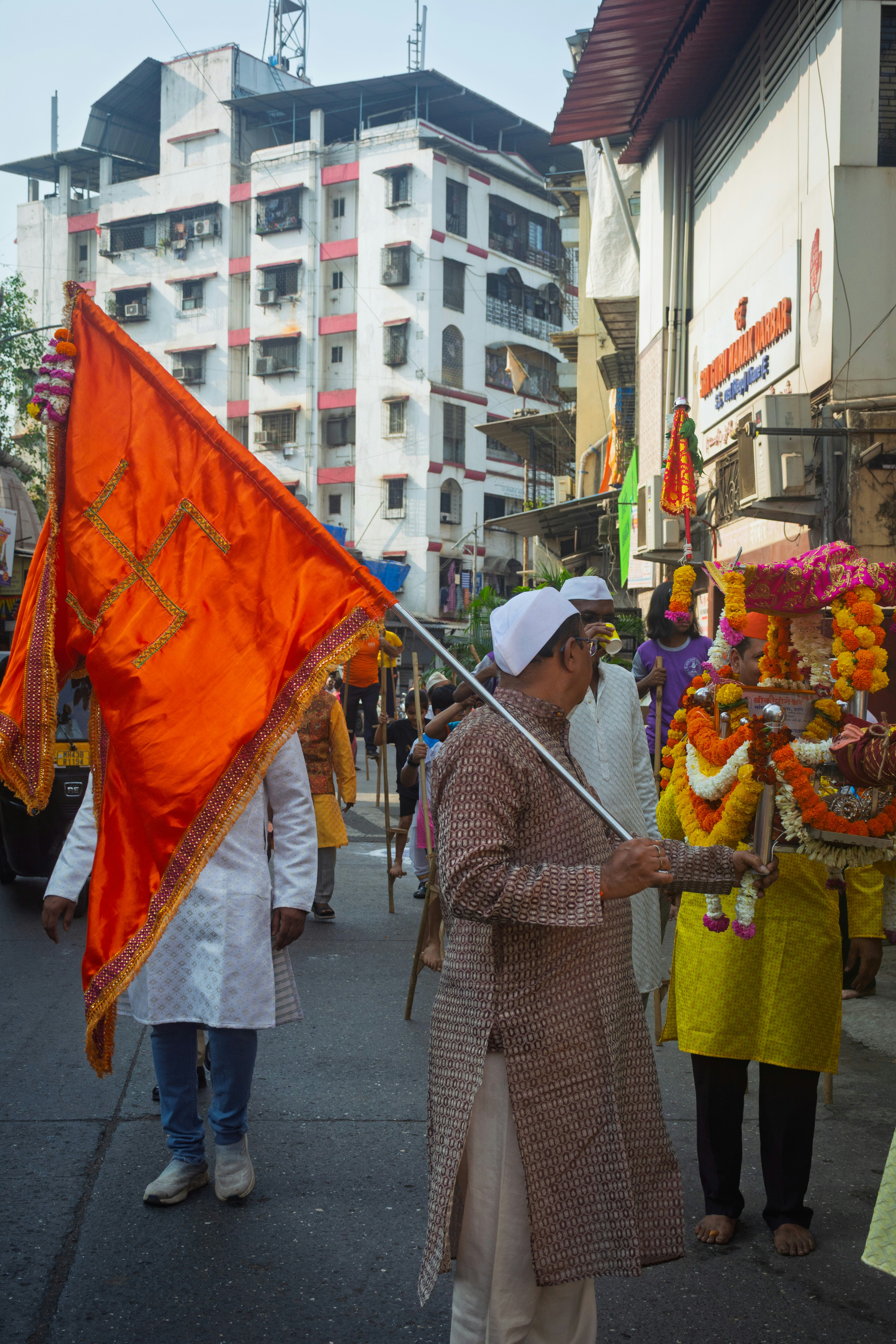 Procession of Color: A Street Festival Framed by Urban Facades